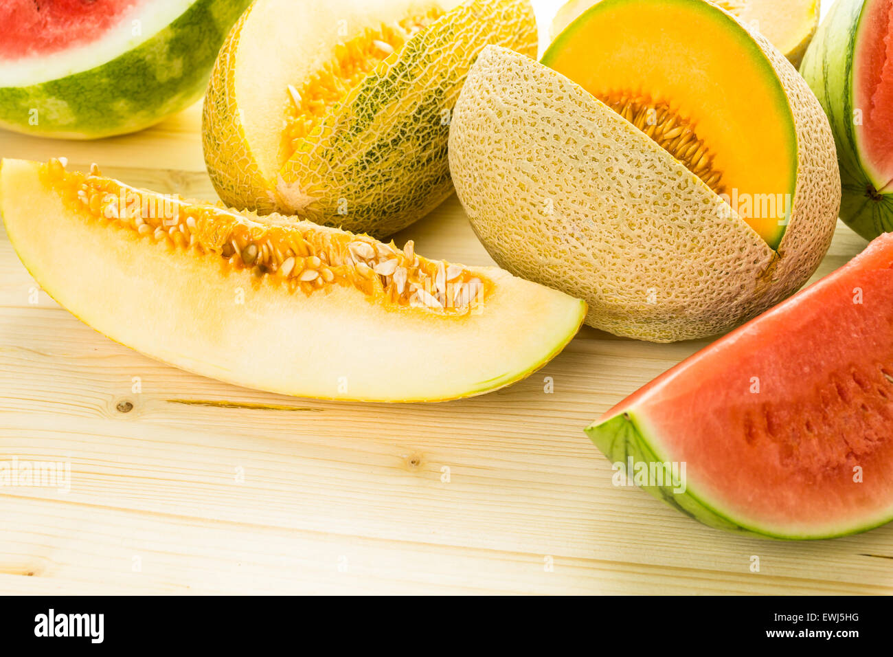 Variety of organic melons sliced on wood table Stock Photo - Alamy