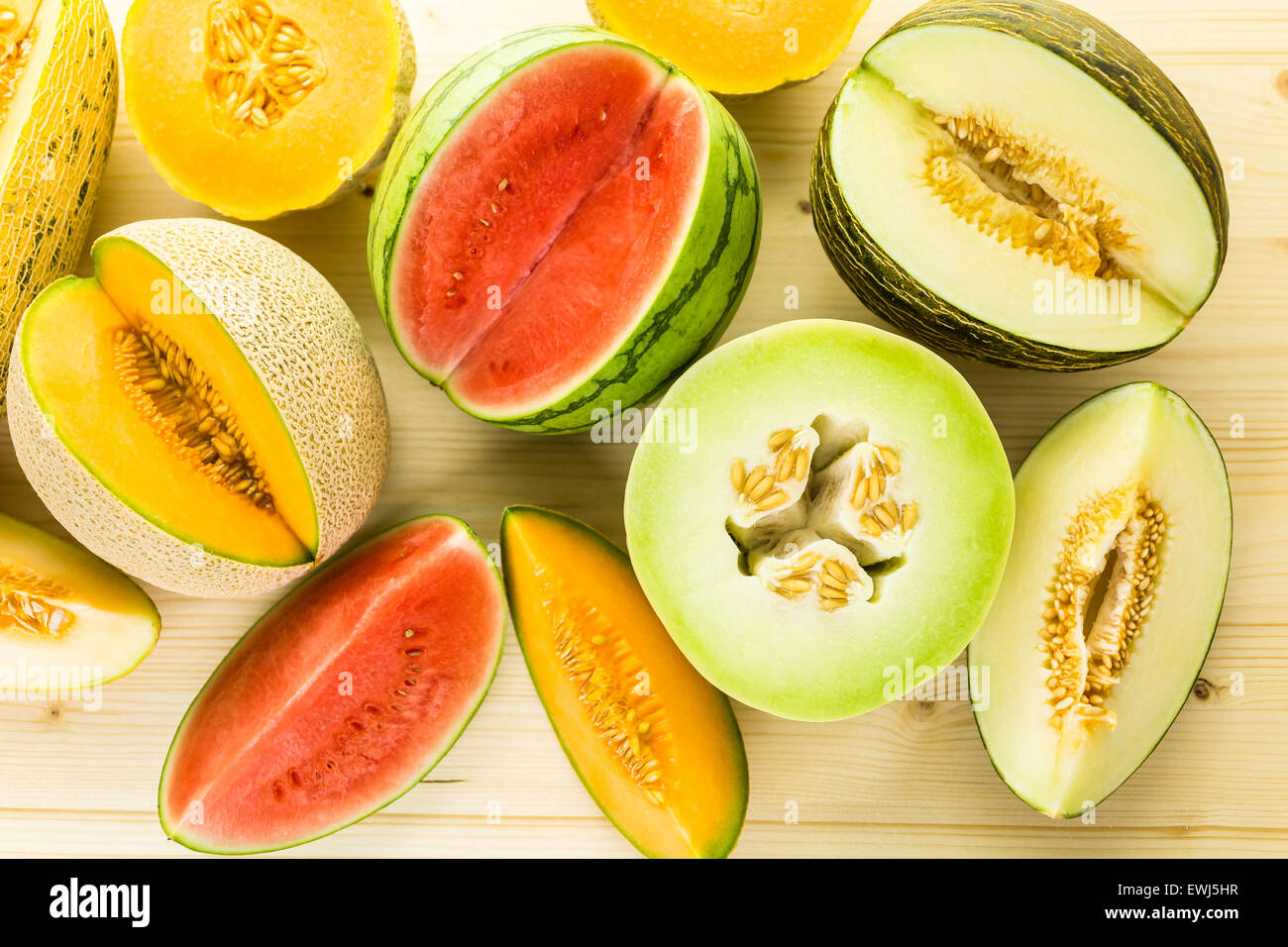 Variety of organic melons sliced on wood table Stock Photo - Alamy