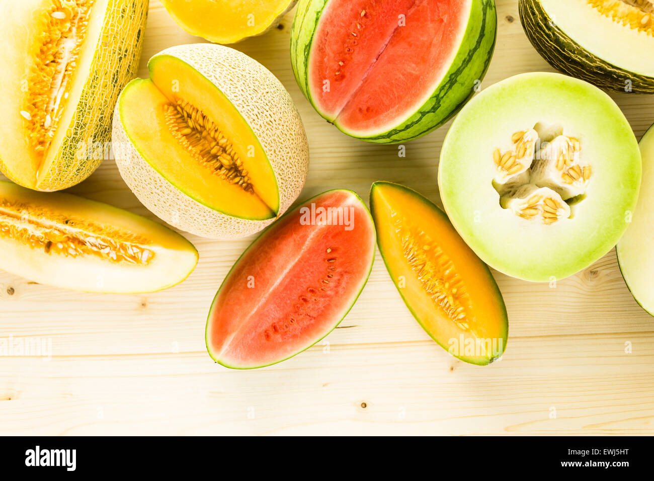 Variety of organic melons sliced on wood table Stock Photo - Alamy