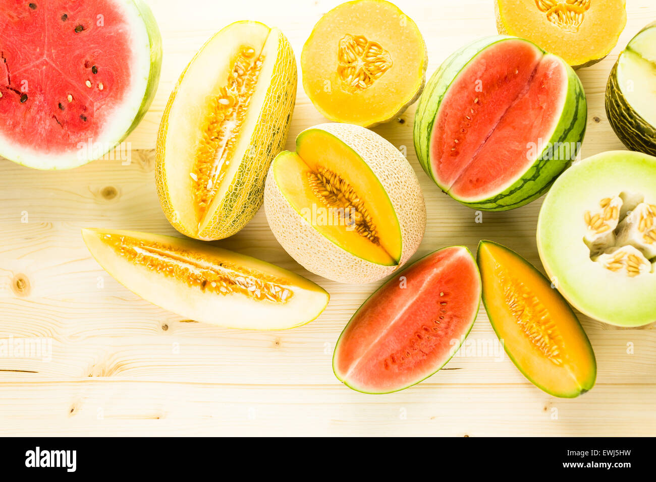 Variety of organic melons sliced on wood table Stock Photo - Alamy