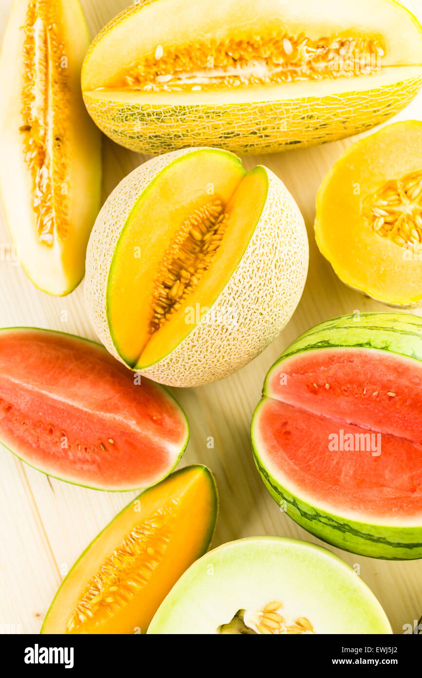 Variety of organic melons sliced on wood table Stock Photo - Alamy