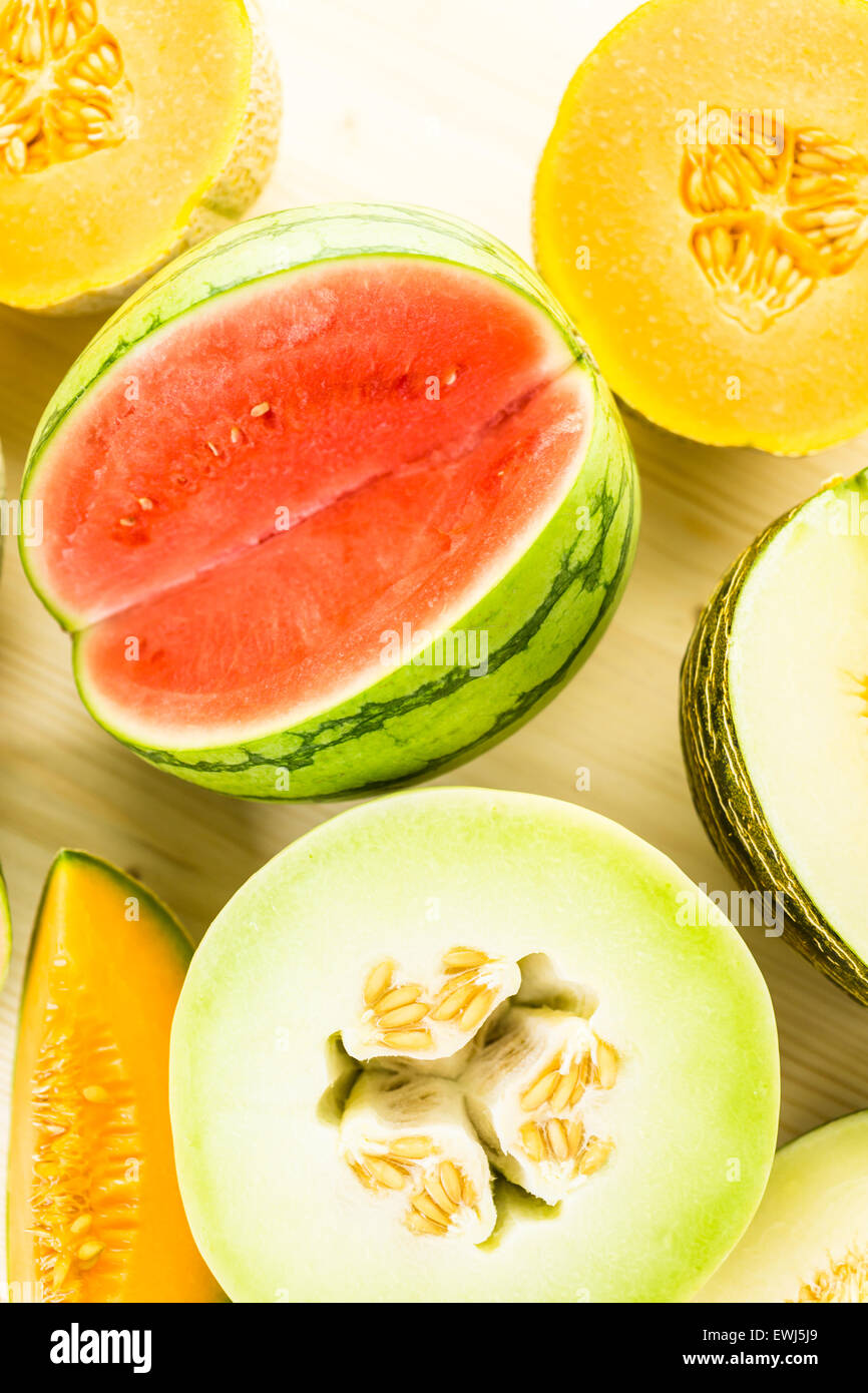 Variety of organic melons sliced on wood table Stock Photo - Alamy