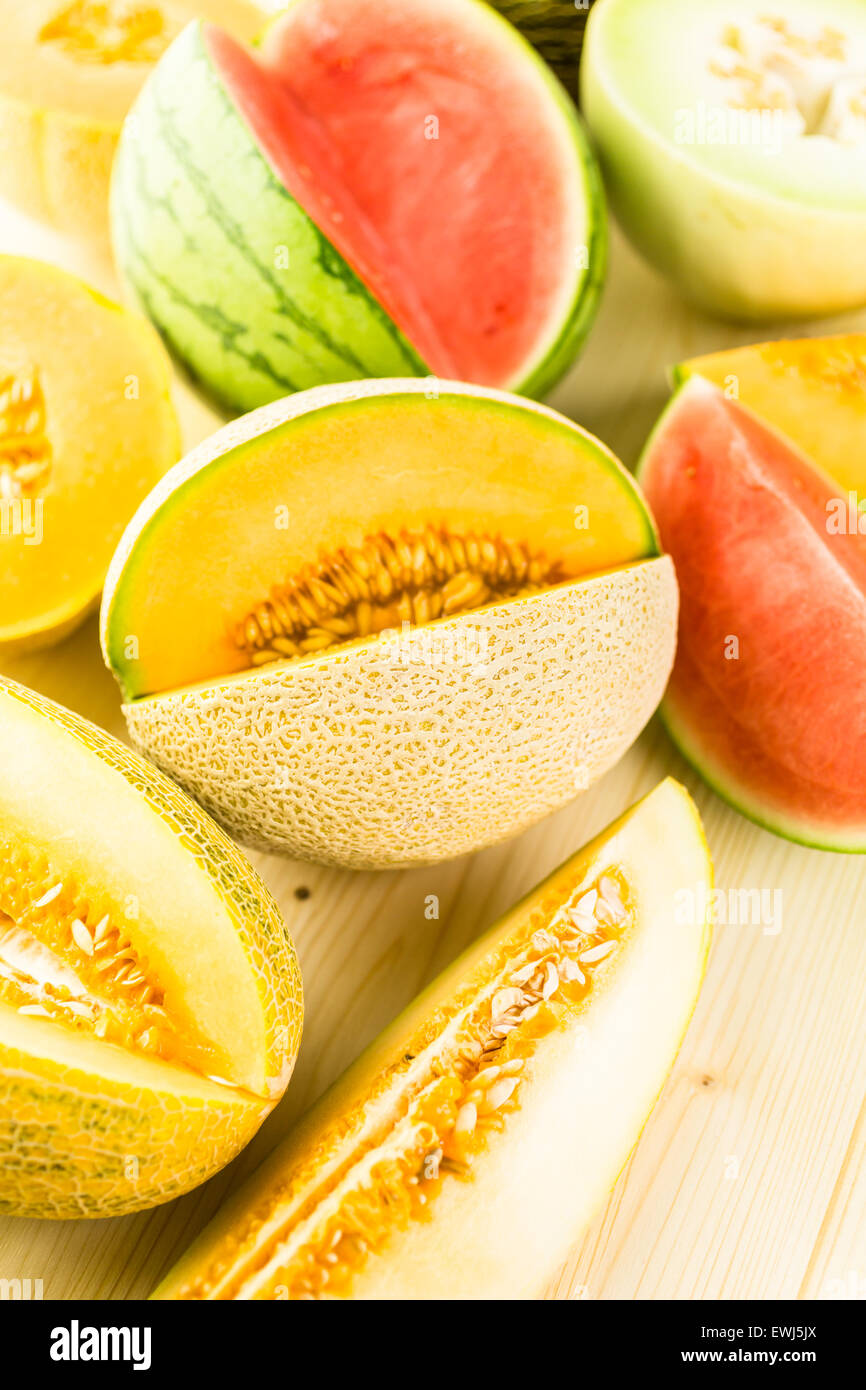 Variety of organic melons sliced on wood table Stock Photo - Alamy