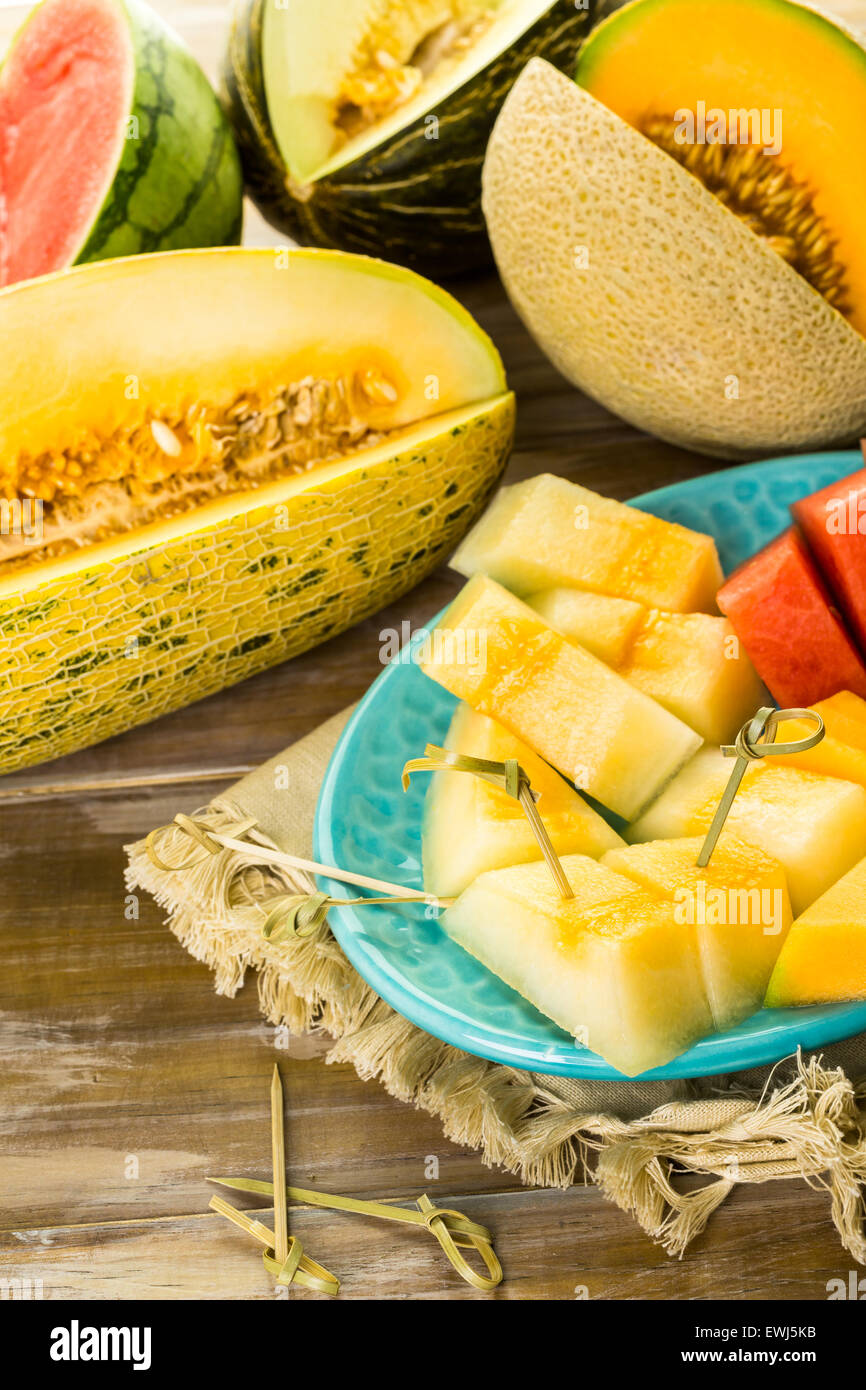 Variety of organic melons sliced on wood table Stock Photo - Alamy