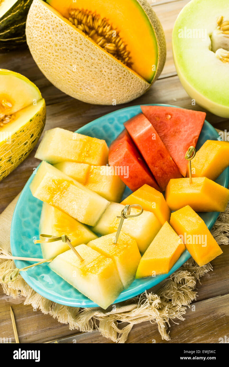 Variety of organic melons sliced on wood table Stock Photo - Alamy