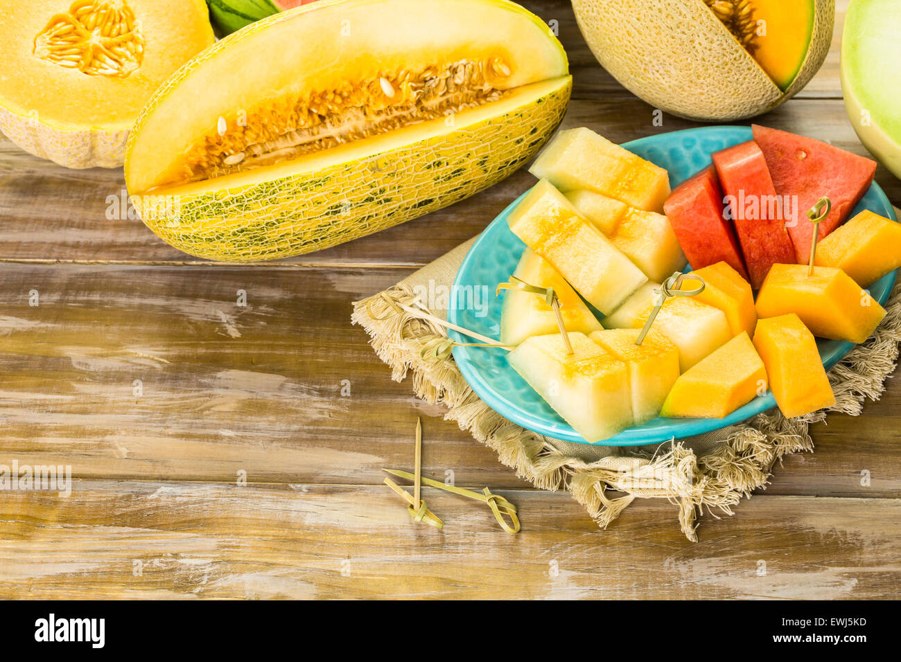 Variety of organic melons sliced on wood table Stock Photo - Alamy