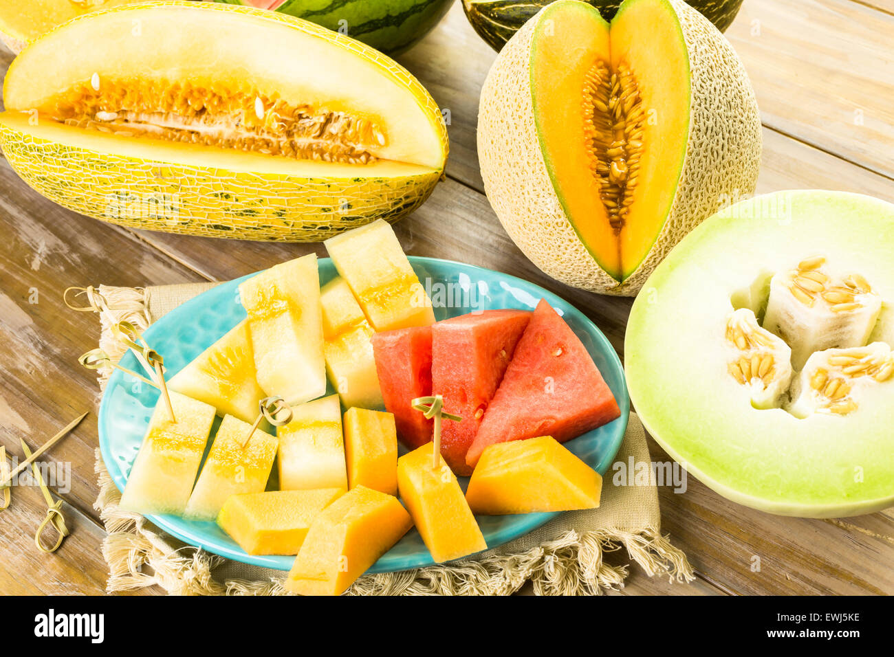 Variety of organic melons sliced on wood table Stock Photo - Alamy