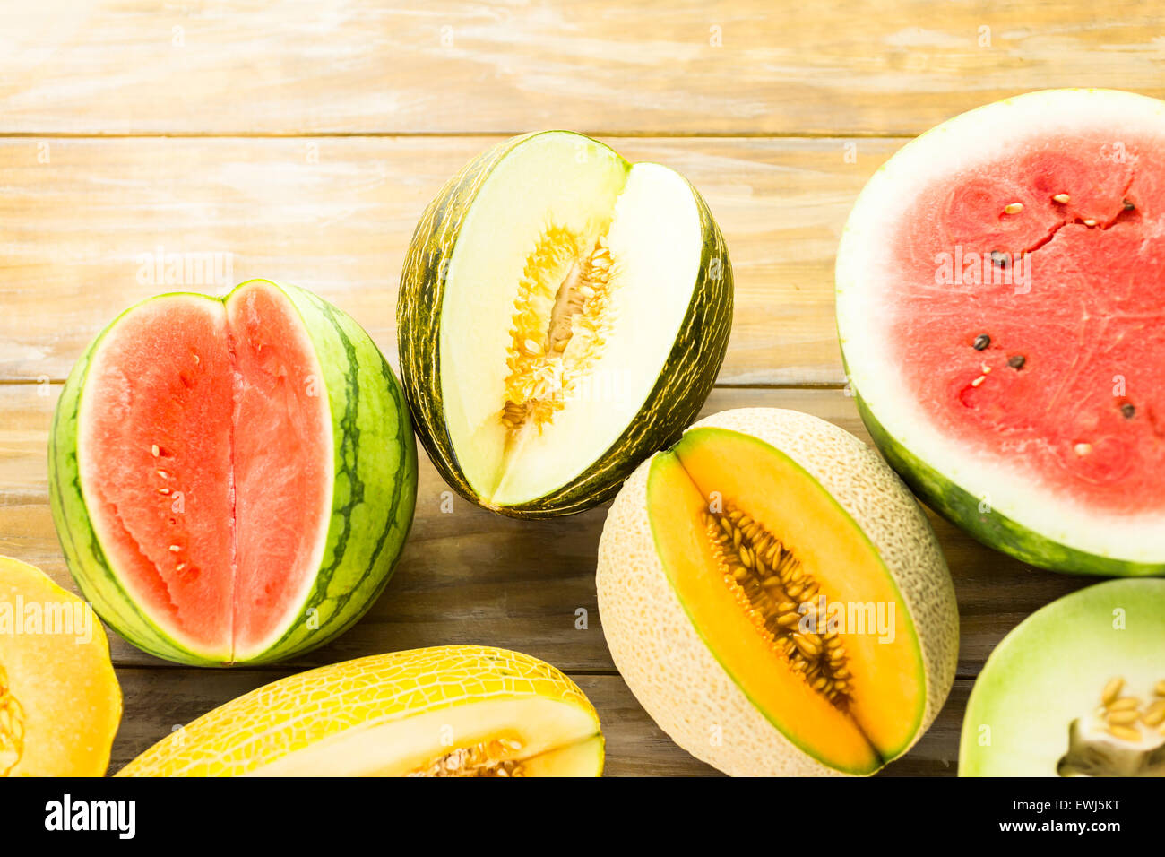 Variety of organic melons sliced on wood table Stock Photo - Alamy