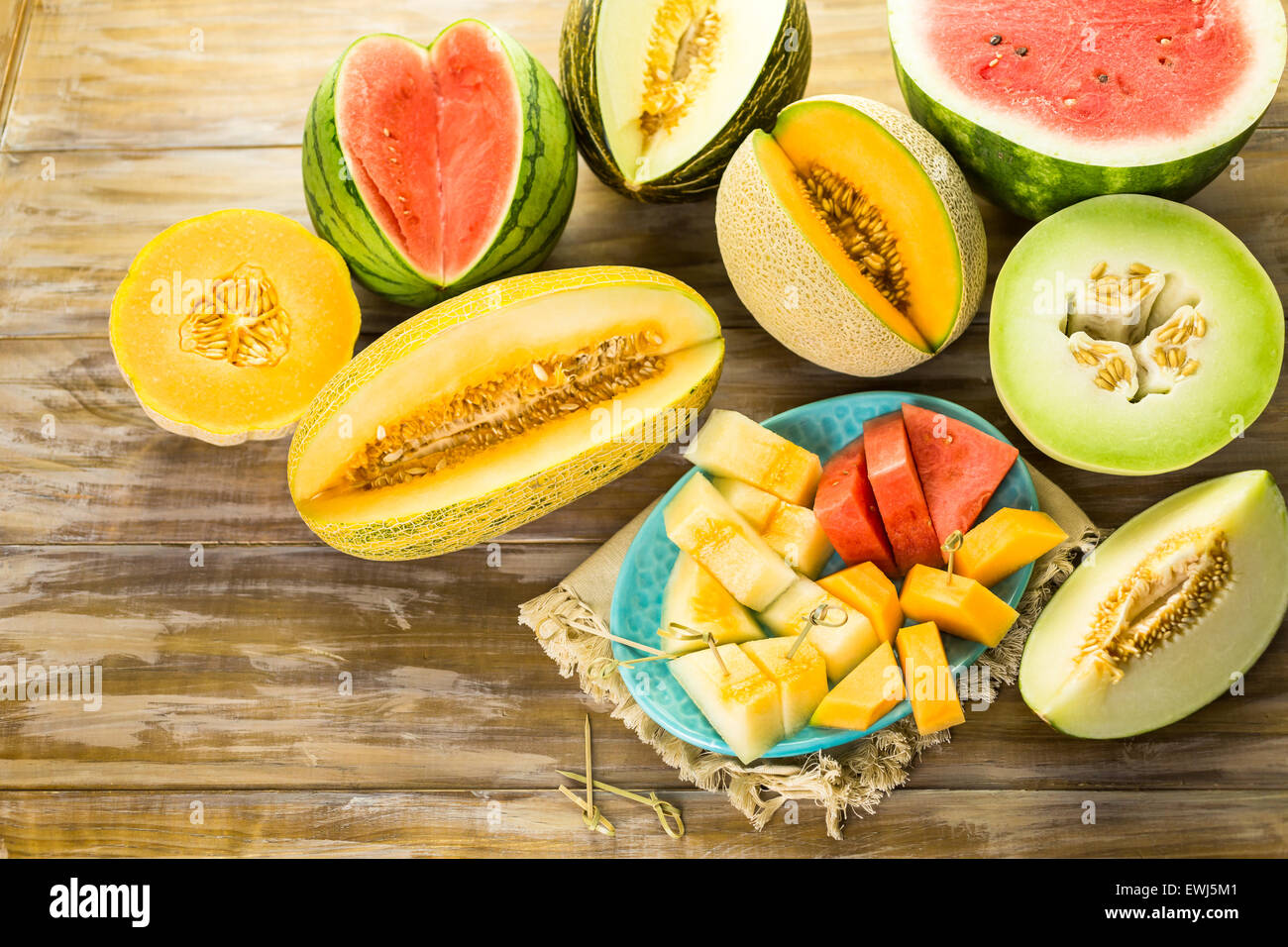 Variety of organic melons sliced on wood table Stock Photo - Alamy