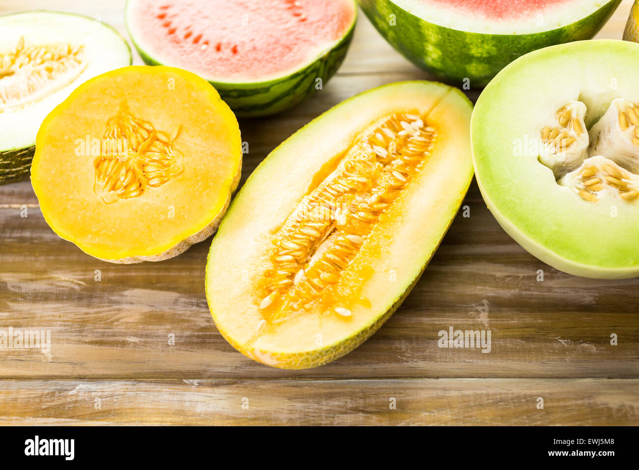 Variety of organic melons sliced on wood table Stock Photo - Alamy