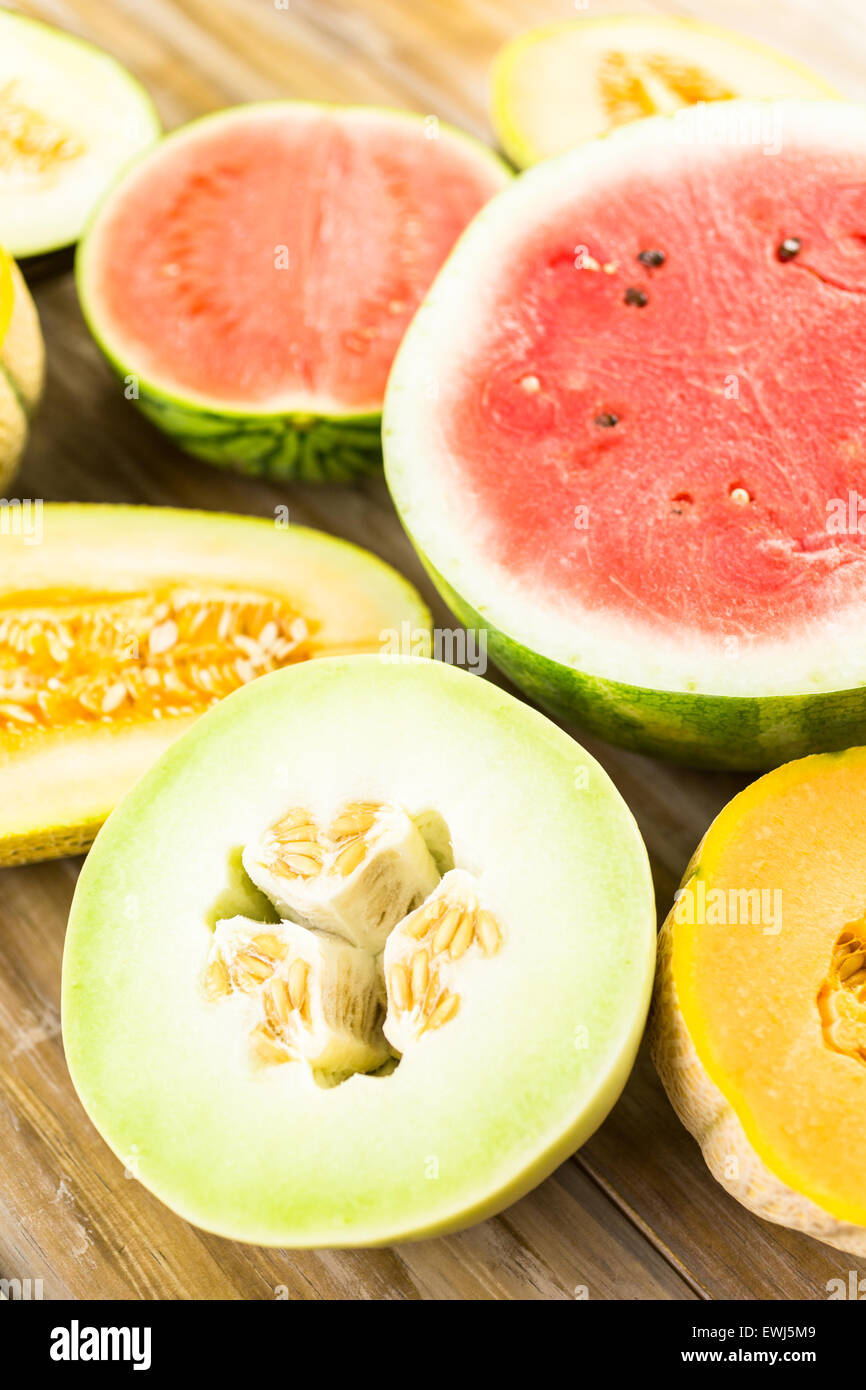 Variety of organic melons sliced on wood table Stock Photo - Alamy
