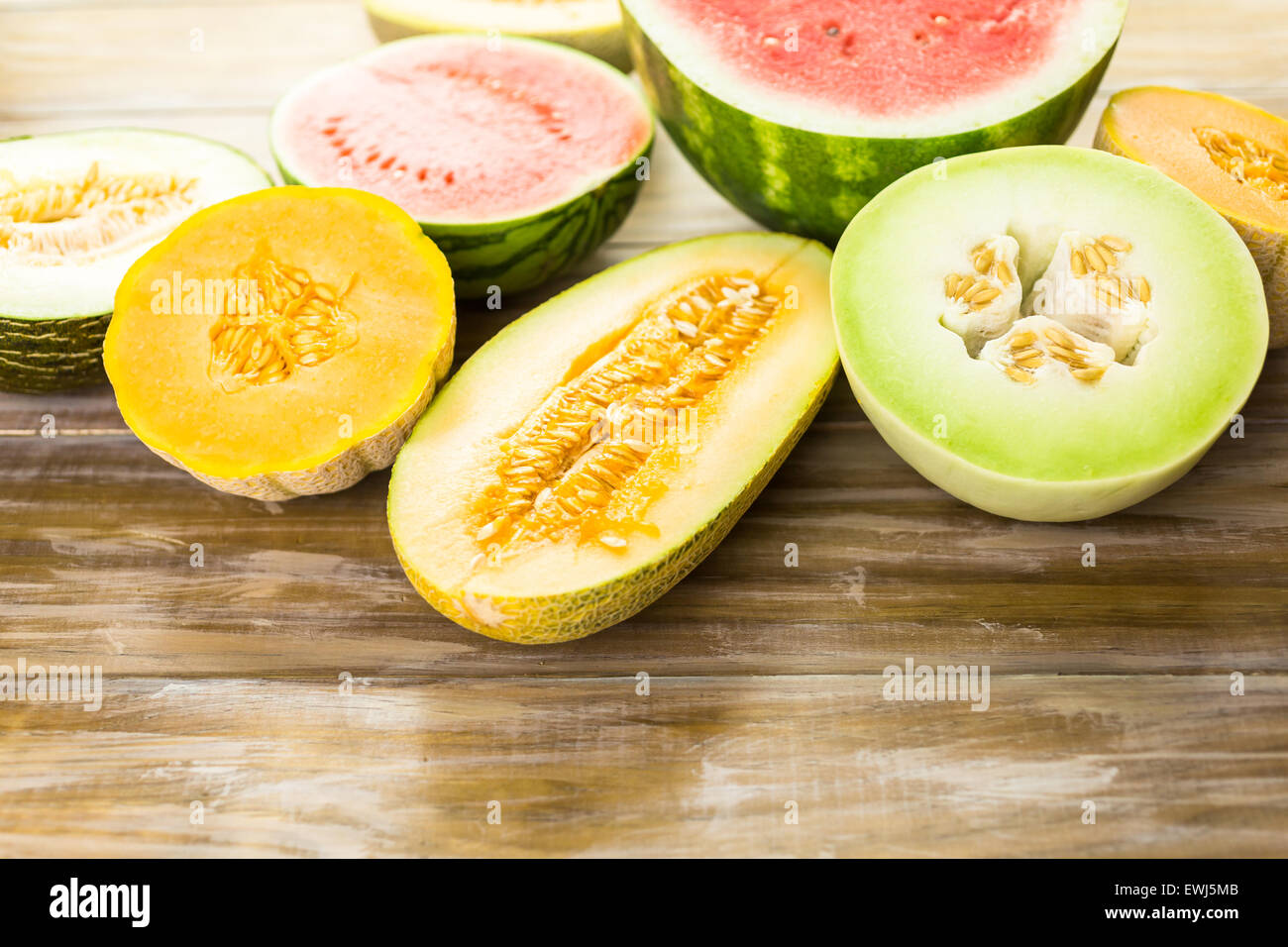 Variety of organic melons sliced on wood table Stock Photo - Alamy