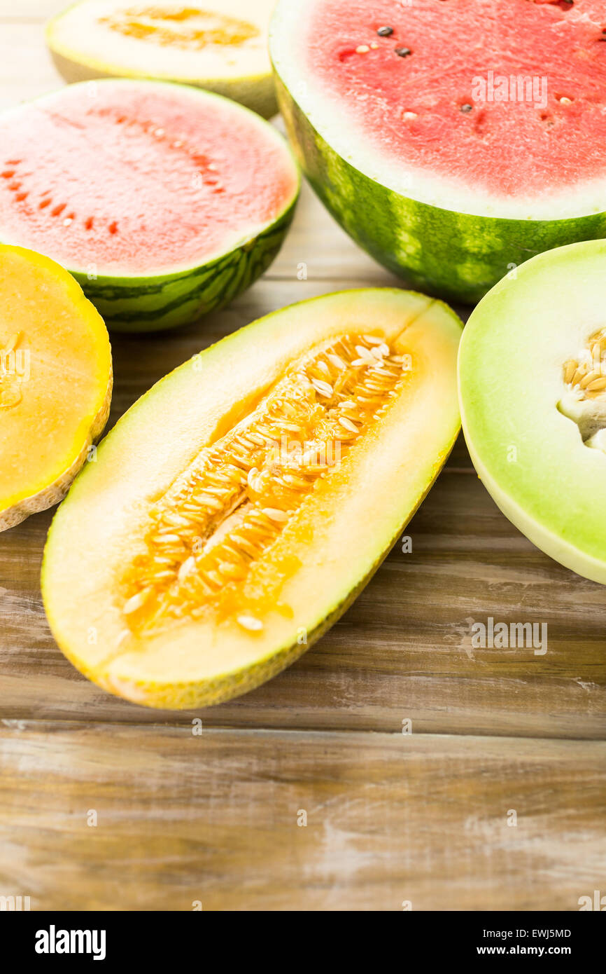 Variety of organic melons sliced on wood table Stock Photo - Alamy