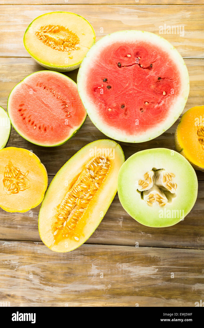 Variety of organic melons sliced on wood table Stock Photo - Alamy