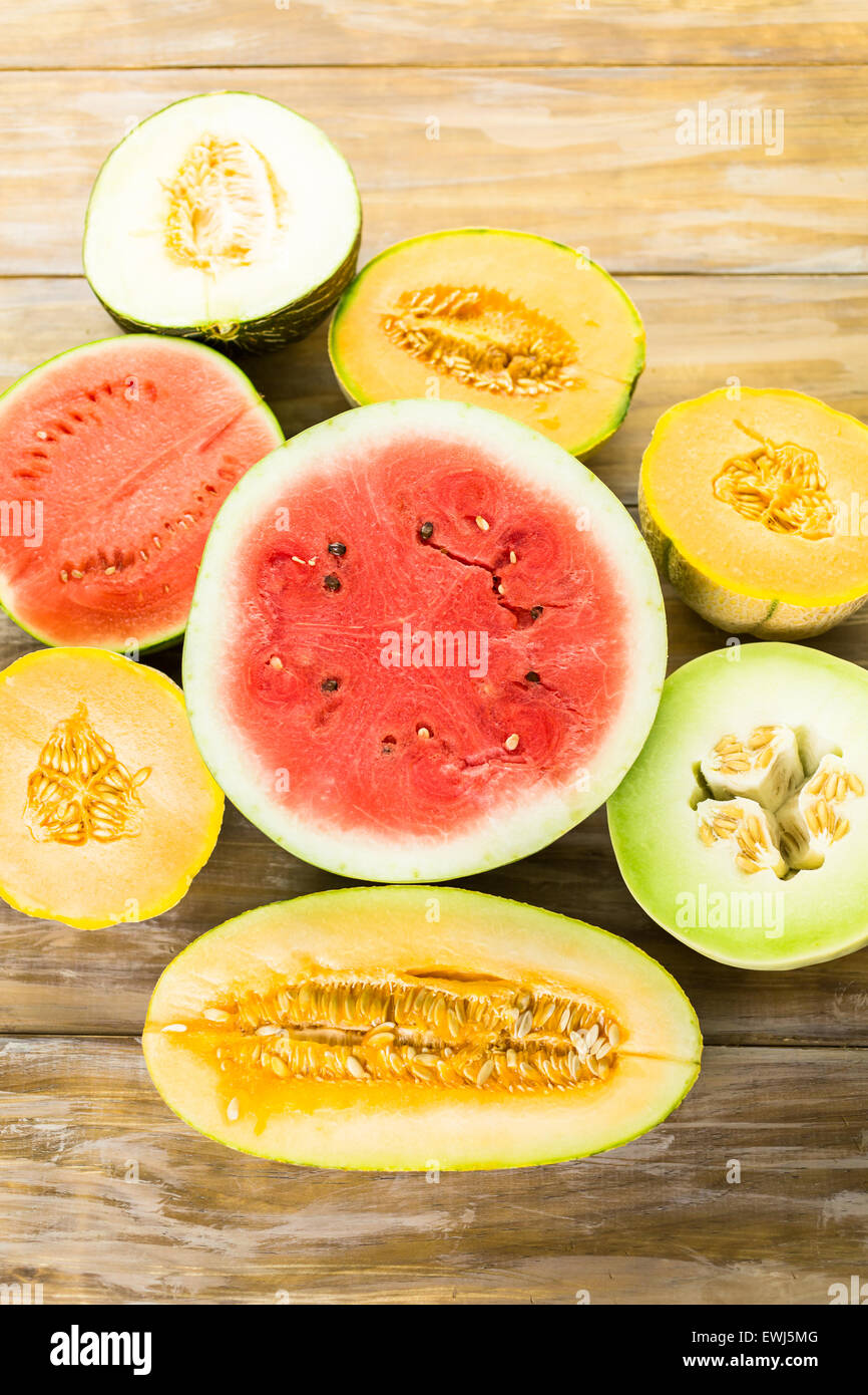 Variety of organic melons sliced on wood table Stock Photo - Alamy