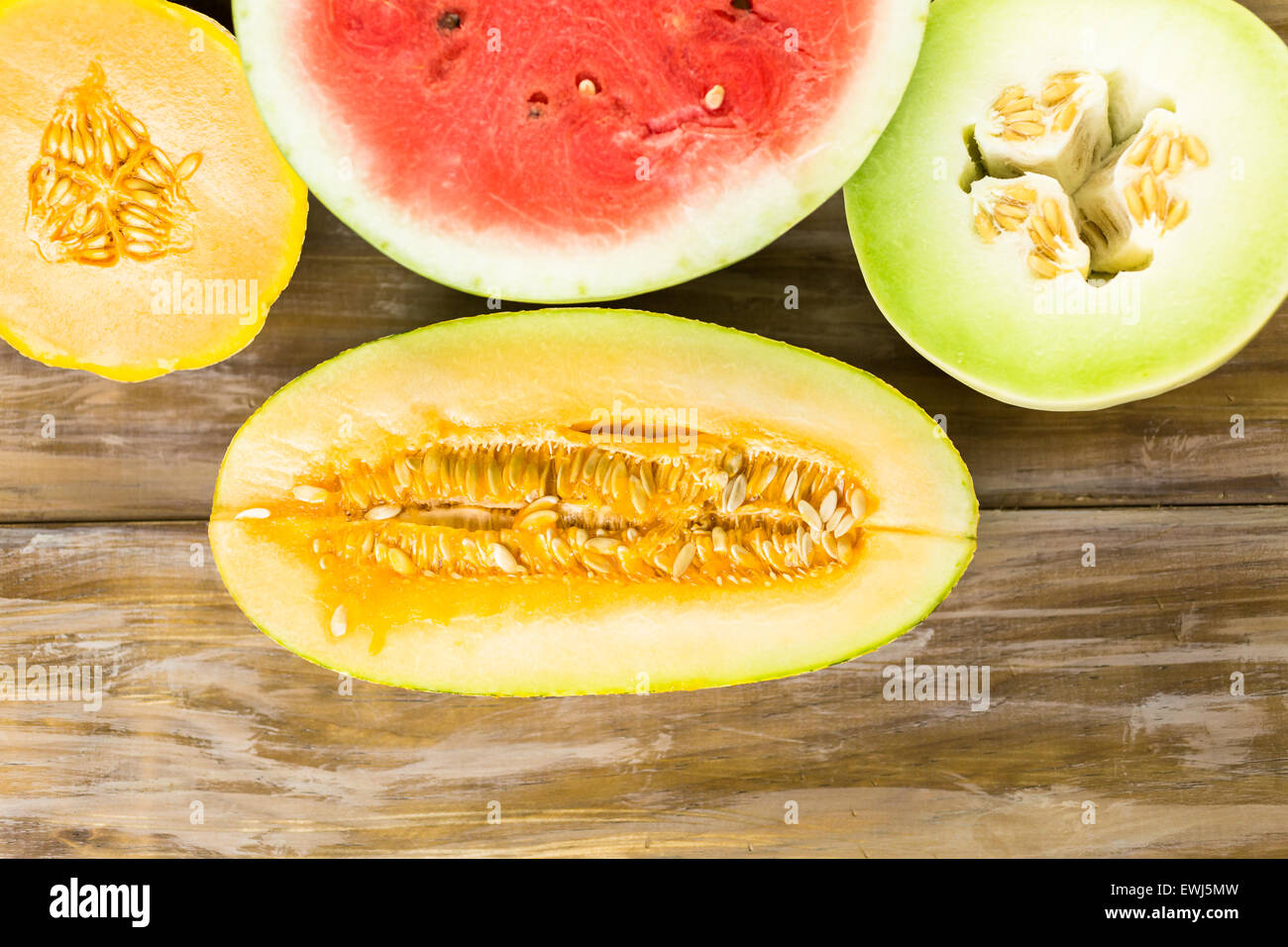 Variety of organic melons sliced on wood table Stock Photo - Alamy
