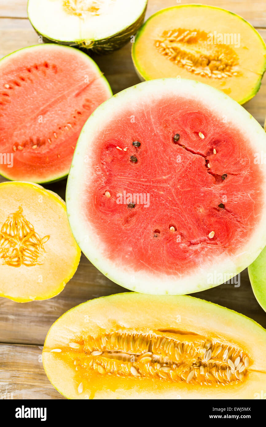 Variety of organic melons sliced on wood table Stock Photo - Alamy