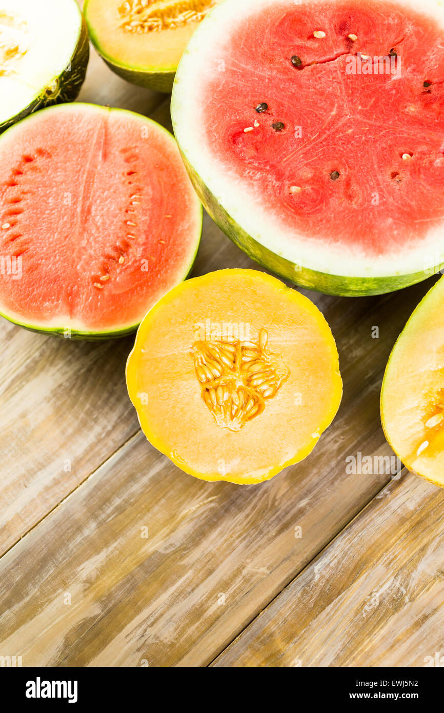Variety of organic melons sliced on wood table Stock Photo - Alamy