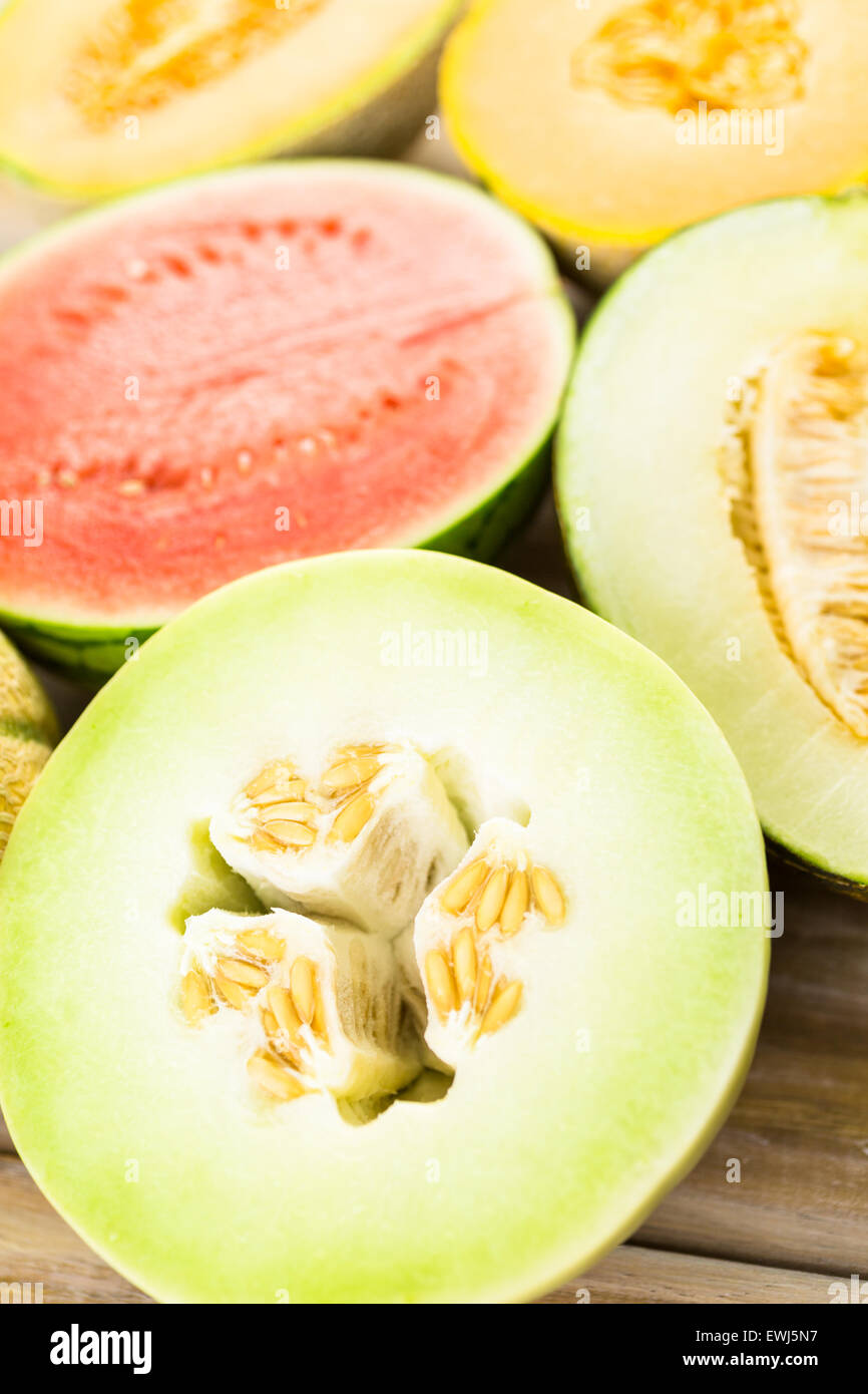 Variety of organic melons sliced on wood table Stock Photo - Alamy