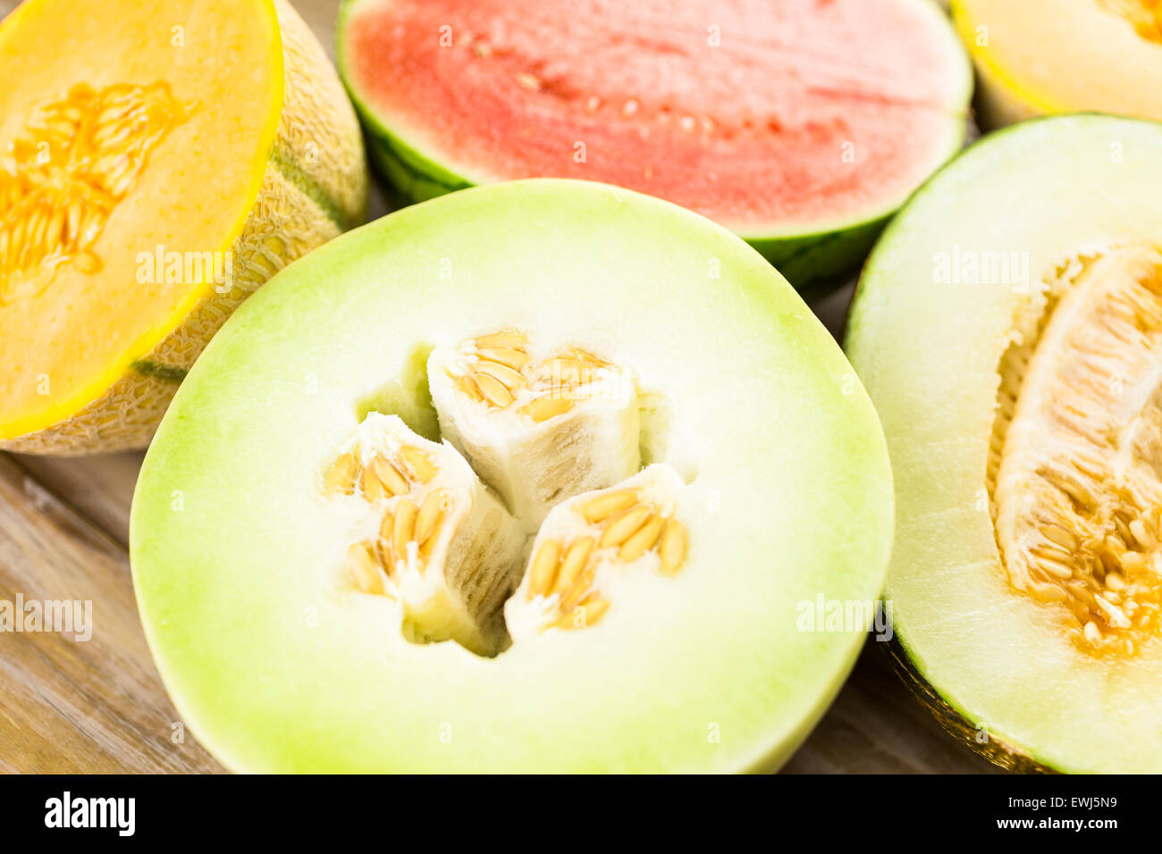 Variety of organic melons sliced on wood table Stock Photo - Alamy