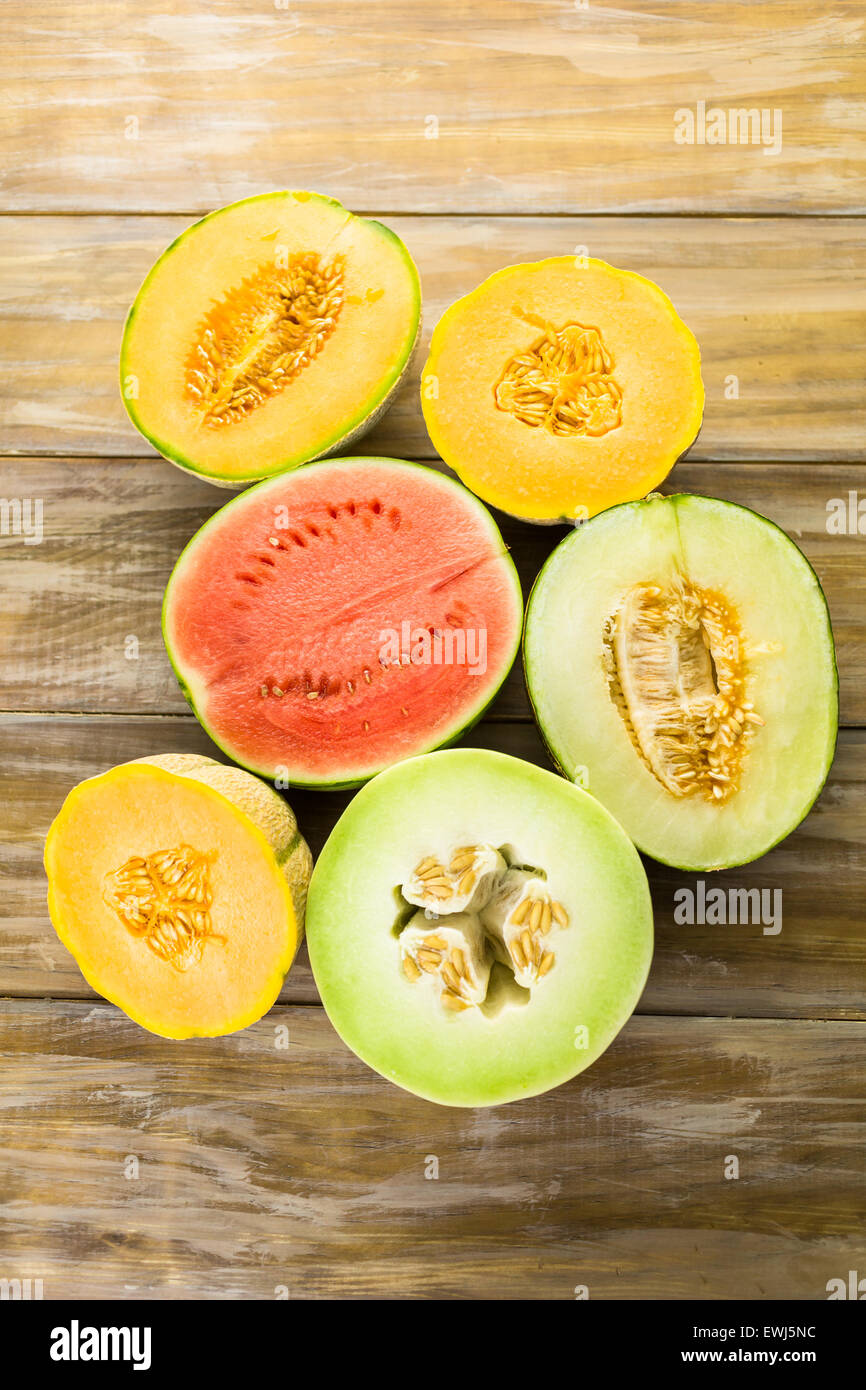 Variety of organic melons sliced on wood table Stock Photo - Alamy