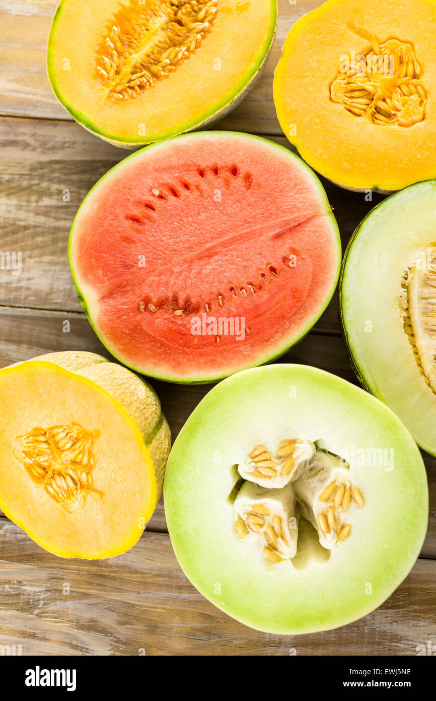 Variety of organic melons sliced on wood table Stock Photo - Alamy