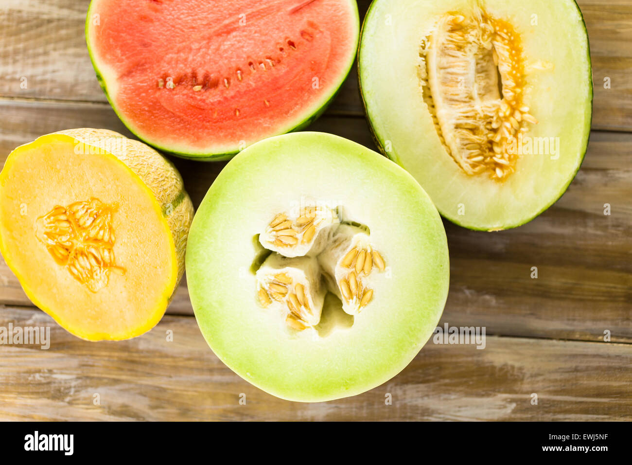 Variety of organic melons sliced on wood table Stock Photo - Alamy