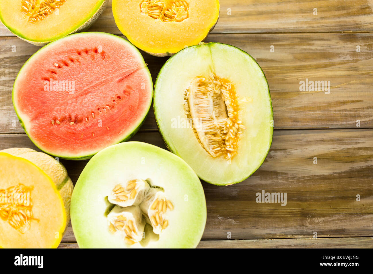 Variety of organic melons sliced on wood table Stock Photo - Alamy