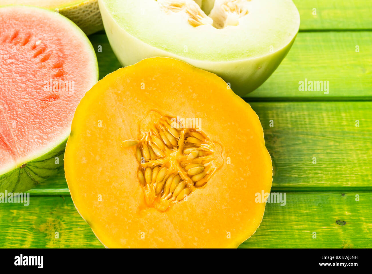 Variety of organic melons sliced on wood table Stock Photo - Alamy