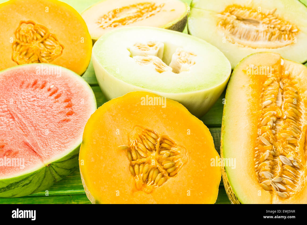 Variety of organic melons sliced on wood table Stock Photo - Alamy