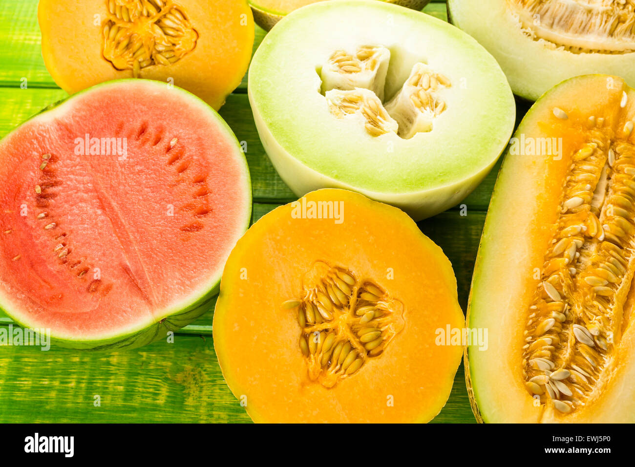 Variety of organic melons sliced on wood table Stock Photo - Alamy