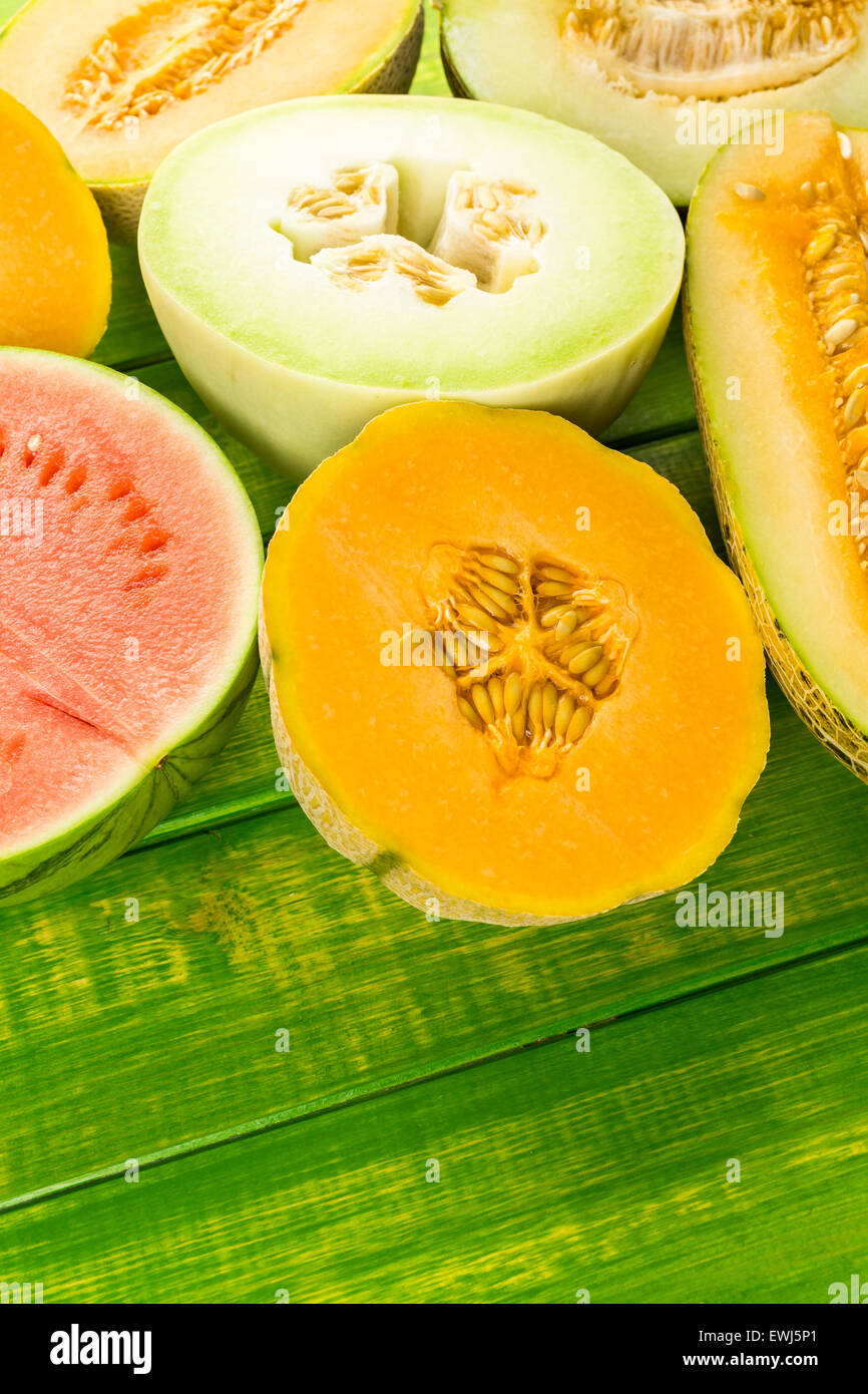 Variety of organic melons sliced on wood table Stock Photo - Alamy