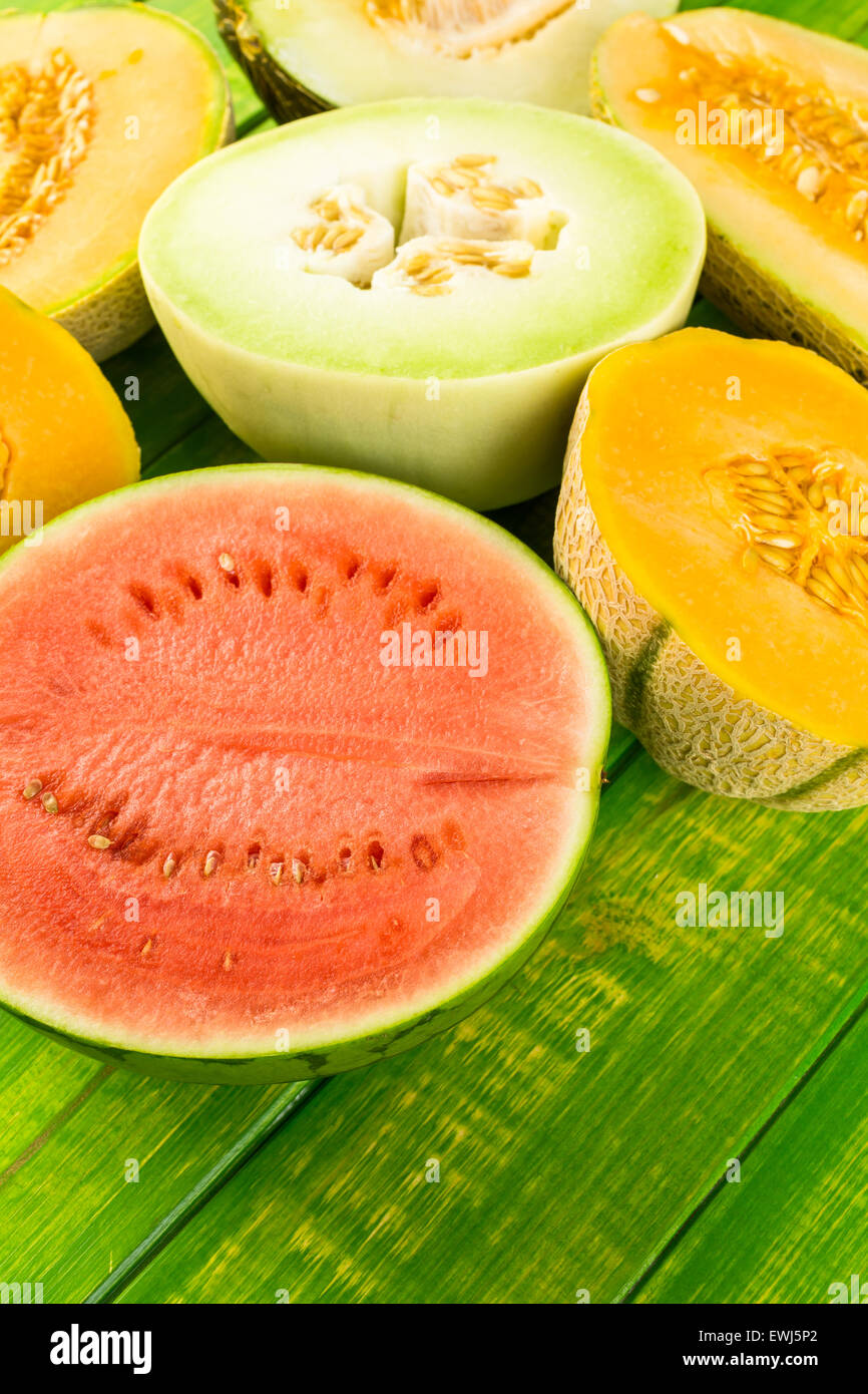 Variety of organic melons sliced on wood table Stock Photo - Alamy