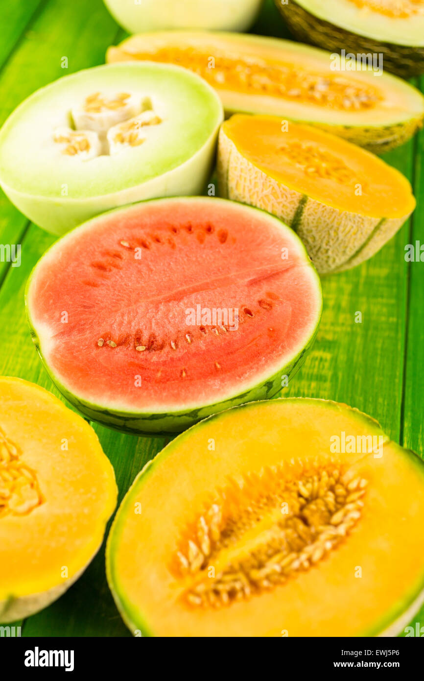 Variety of organic melons sliced on wood table Stock Photo - Alamy