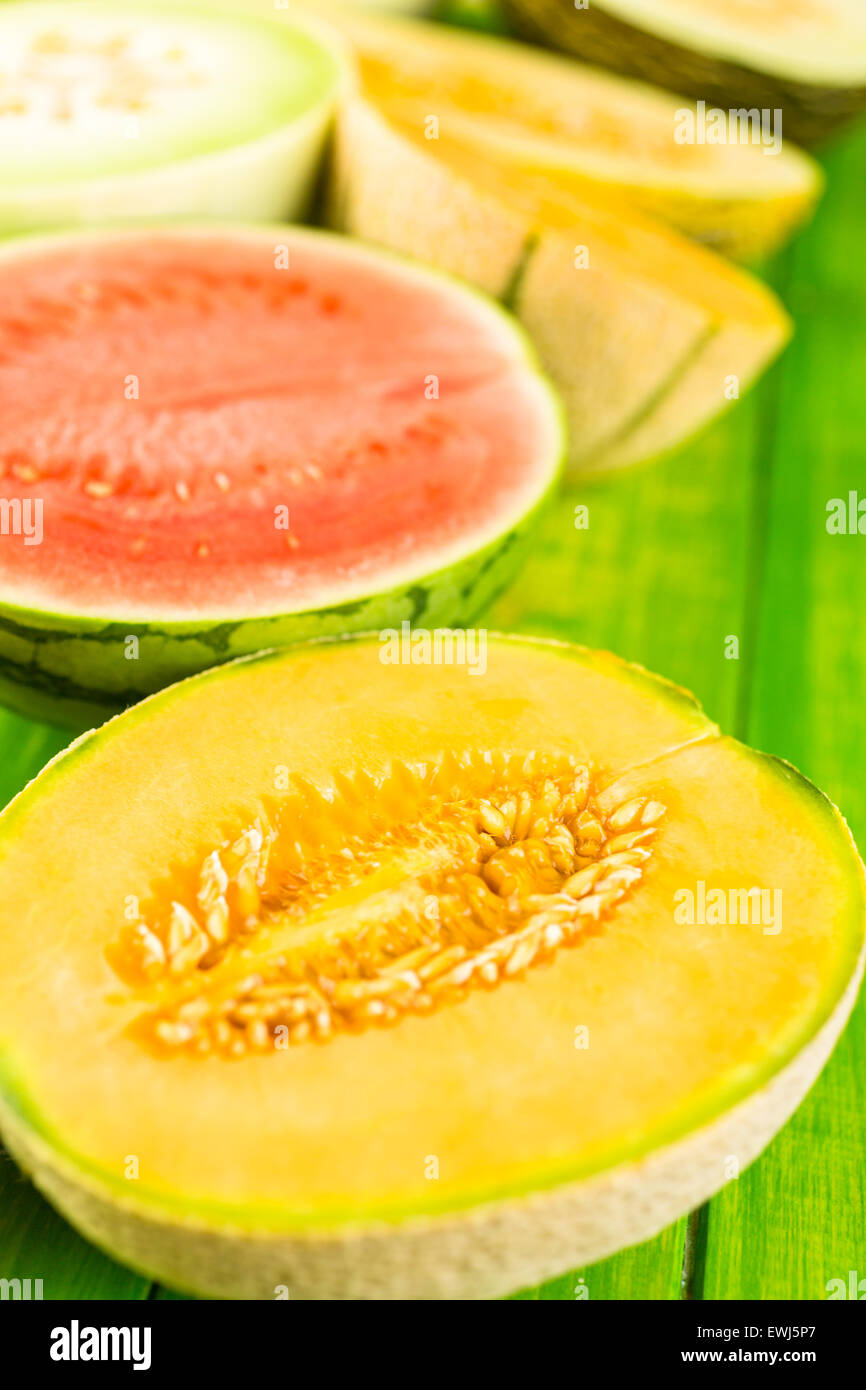 Variety of organic melons sliced on wood table Stock Photo - Alamy