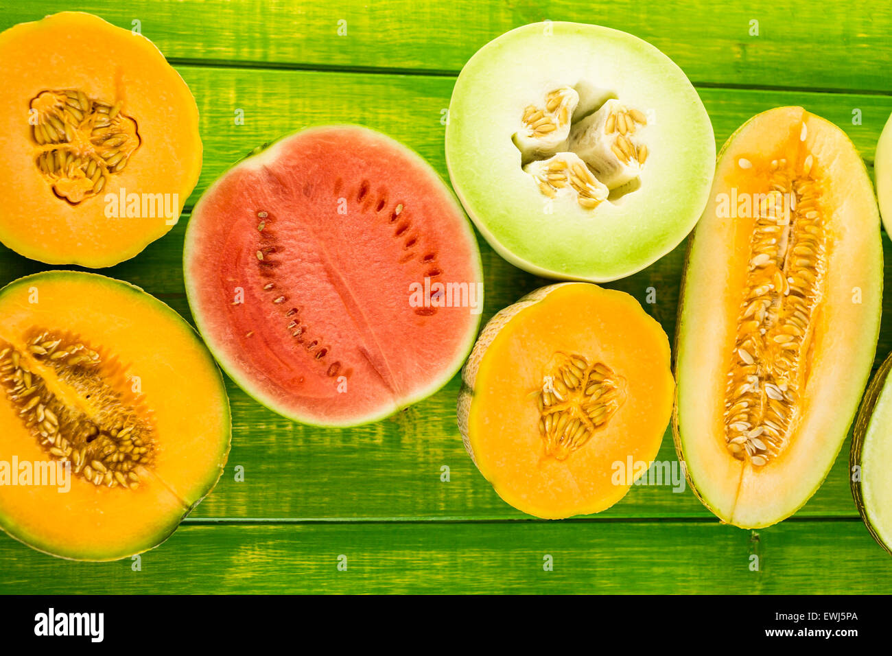Variety of organic melons sliced on wood table Stock Photo - Alamy