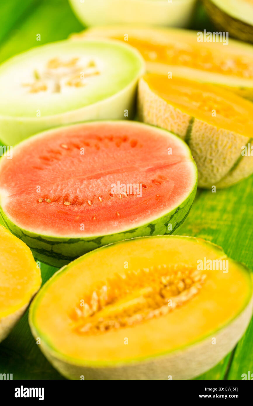 Variety of organic melons sliced on wood table Stock Photo - Alamy