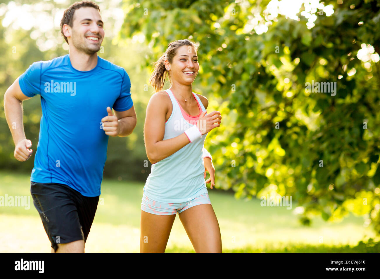 Young couple running Stock Photo - Alamy