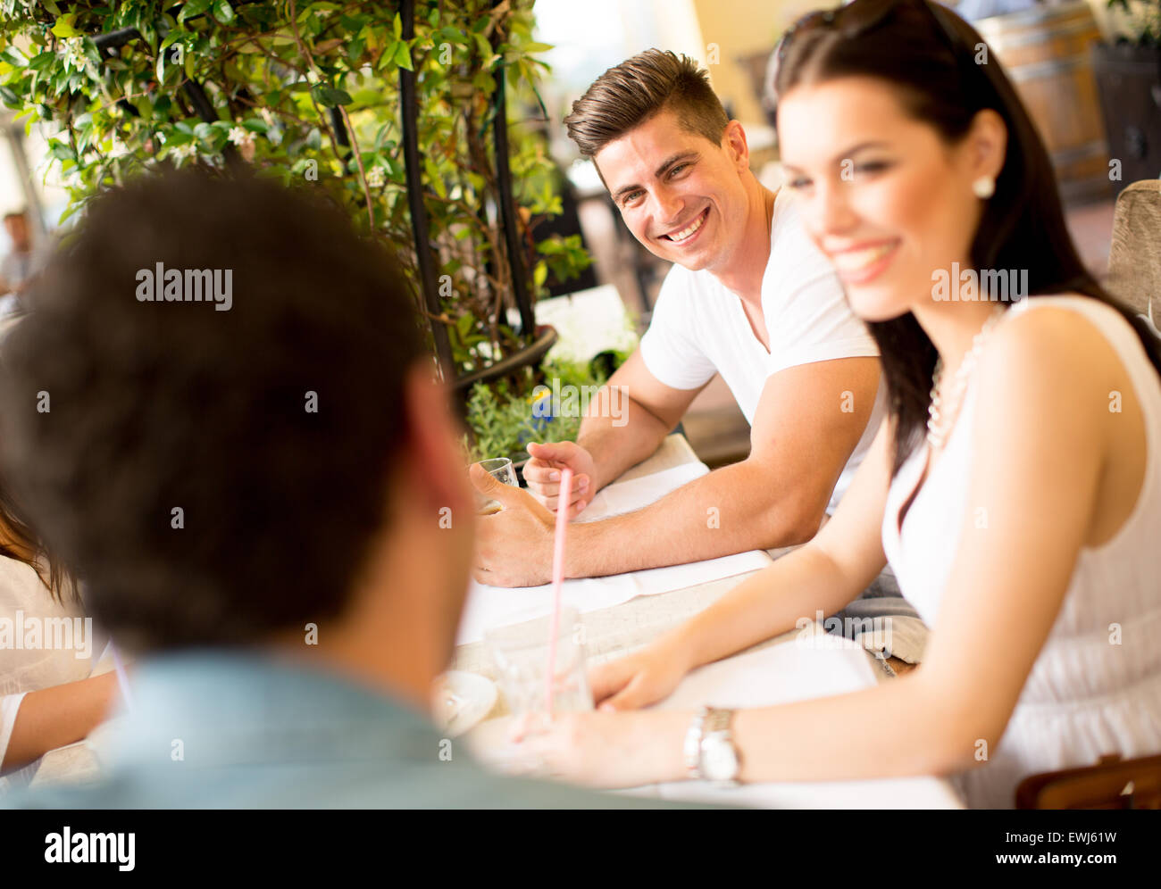 Young people by the table Stock Photo - Alamy