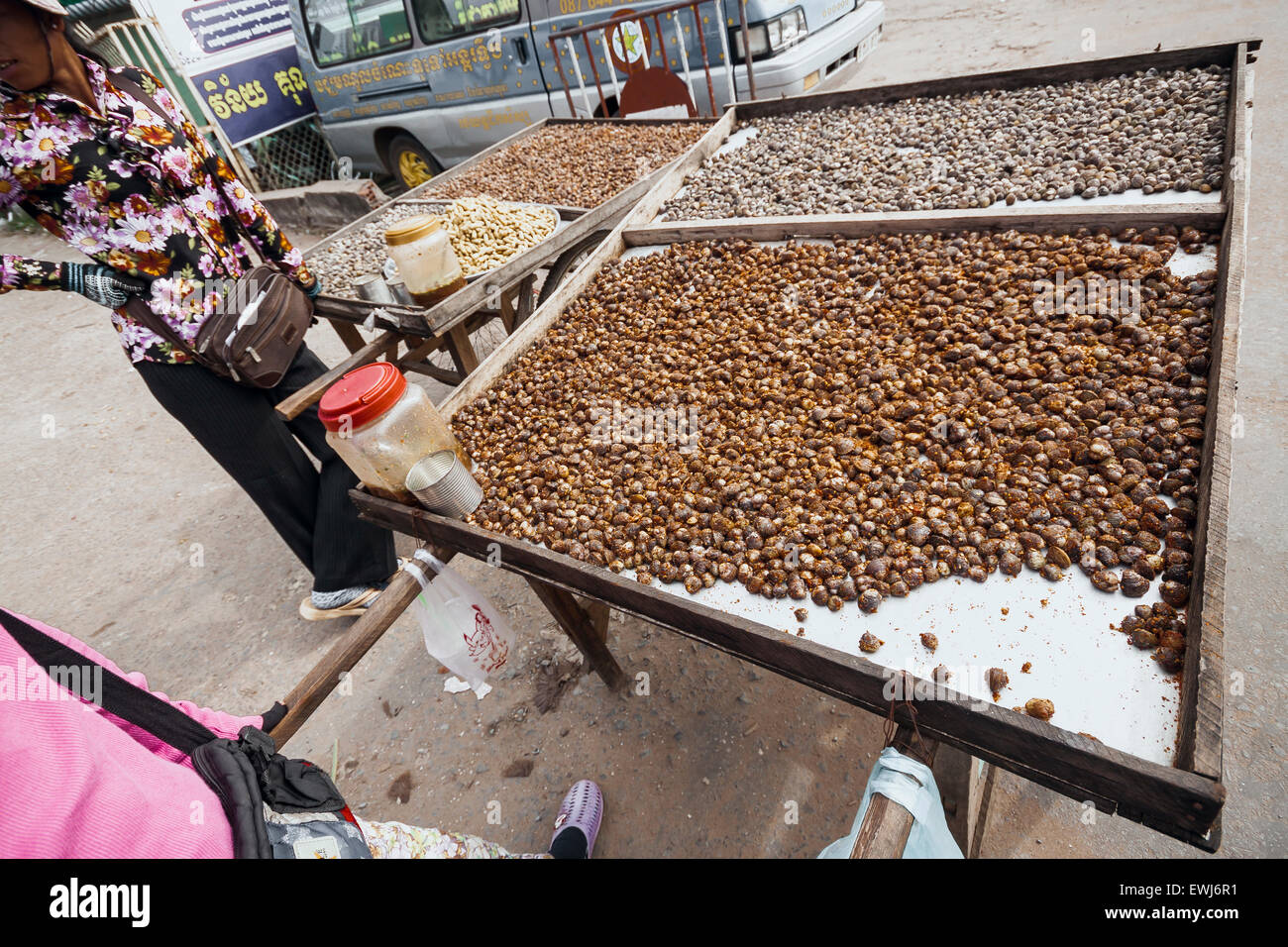 Vendor selling cooked hot and spicy shells on the street in Phnom Penh ...