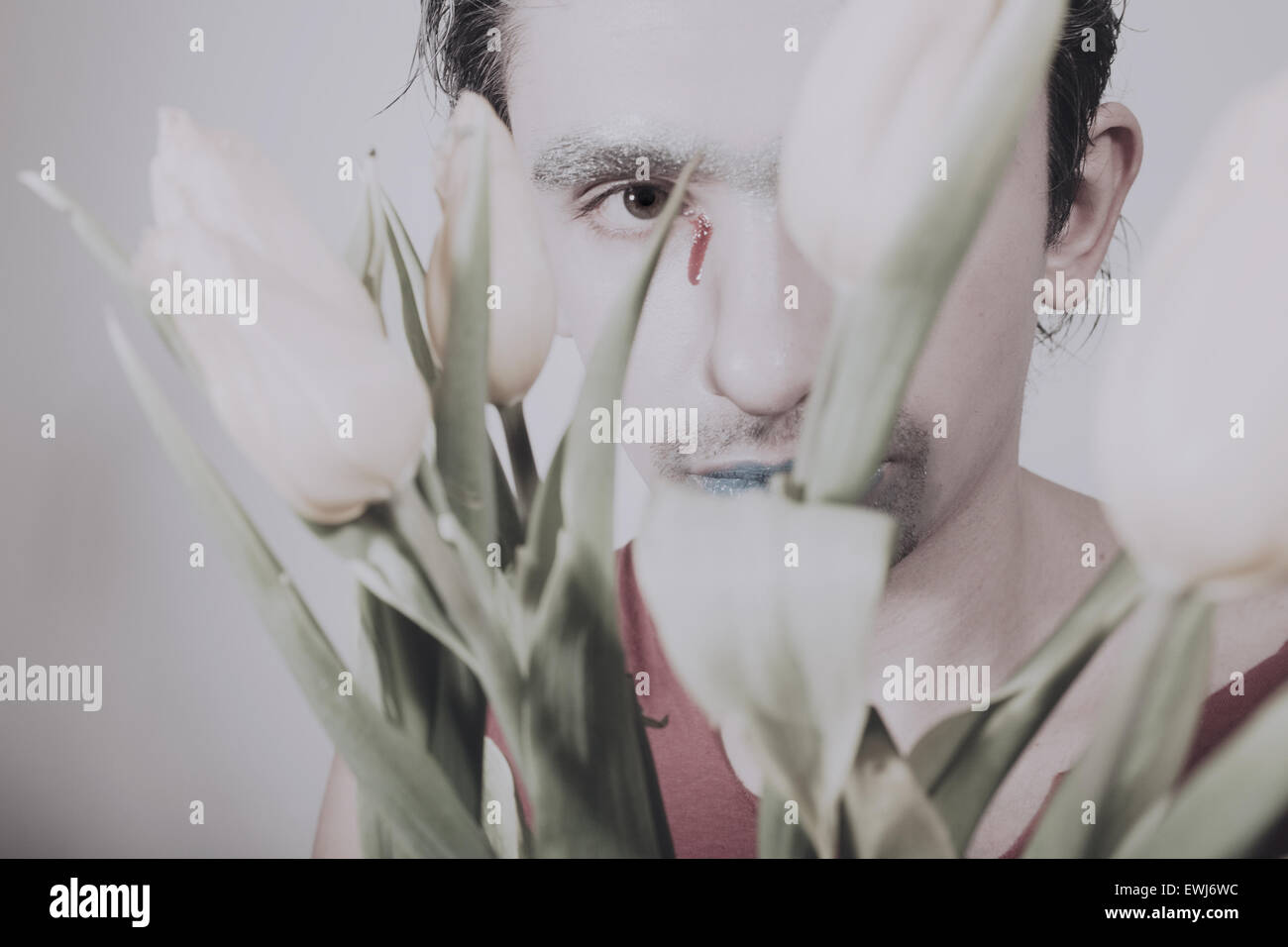 Face of young man with flower on white background Stock Photo - Alamy