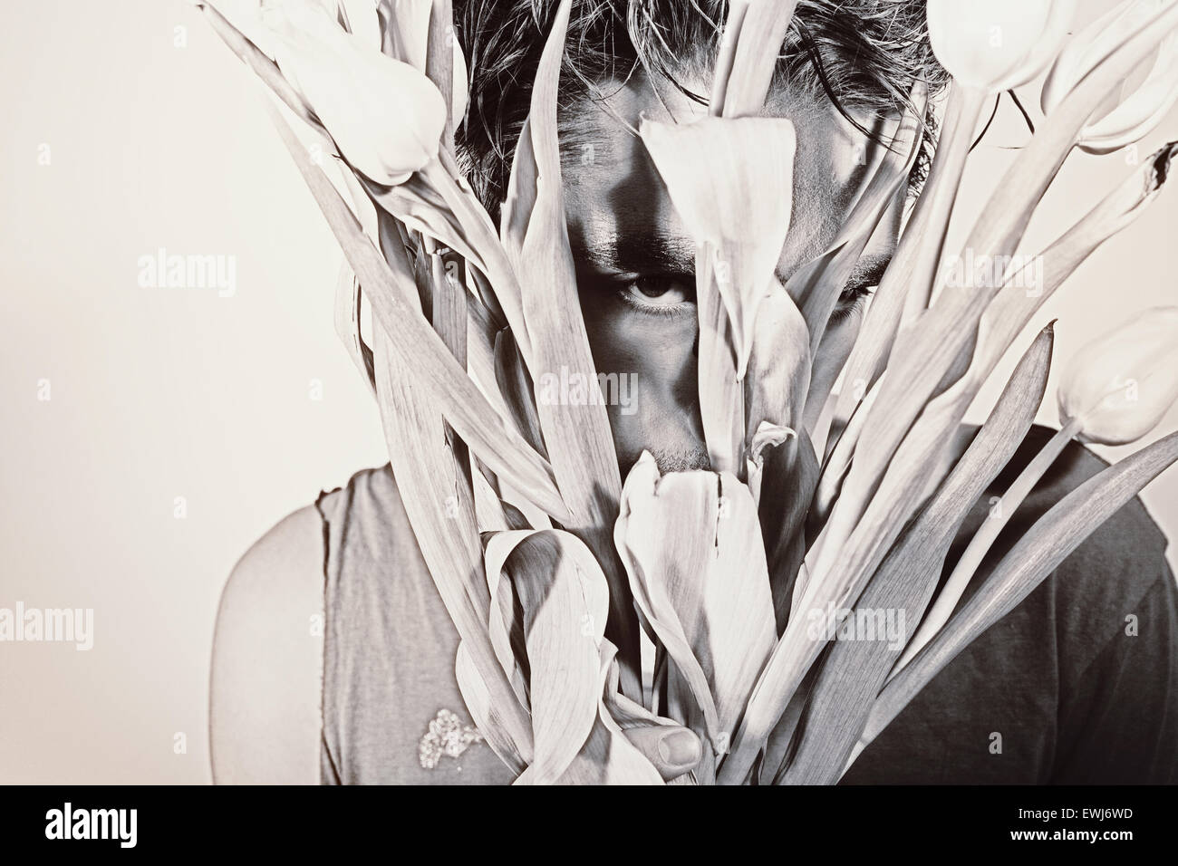 Face of young man with flower on white background Stock Photo - Alamy