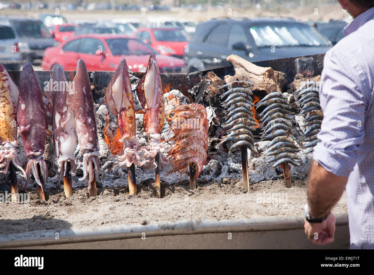 spanish typical fish espetos cooking in Malaga Stock Photo - Alamy