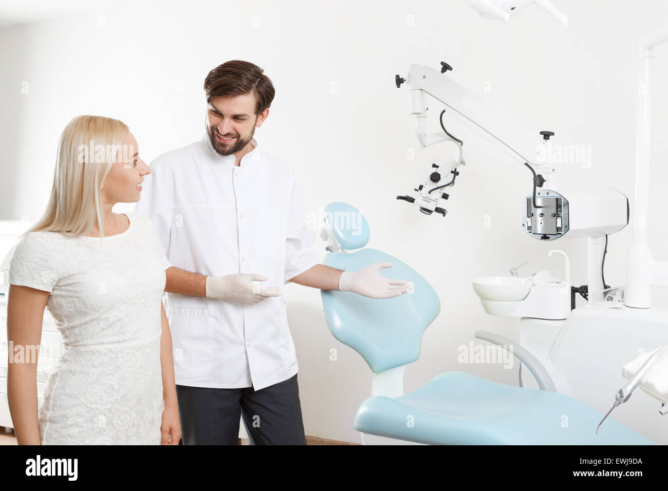 Dentist showing to client working place Stock Photo - Alamy