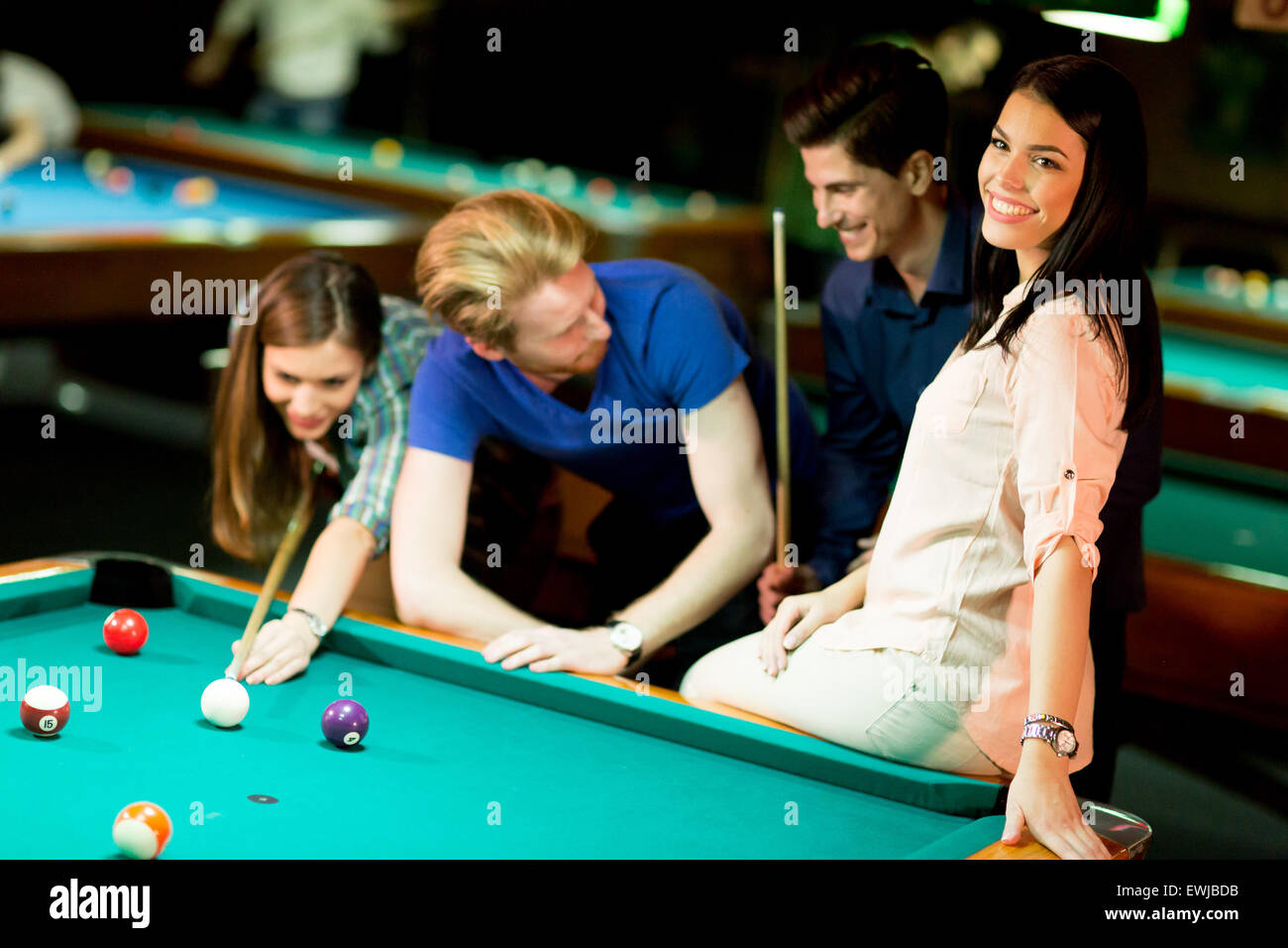 Young people playing pool Stock Photo - Alamy