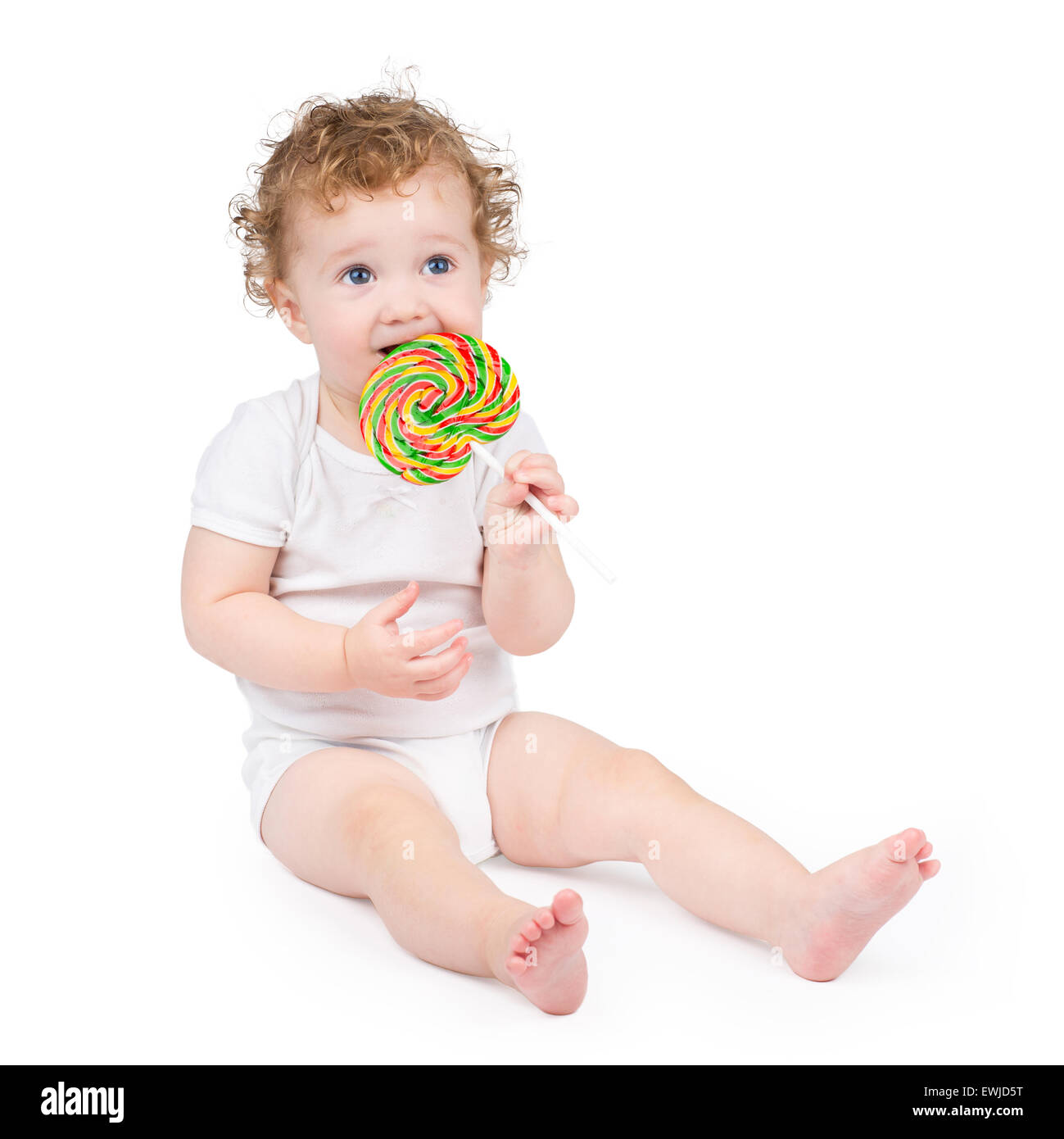 Cute baby with big blue eyes with a colorful candy, isolated on white ...