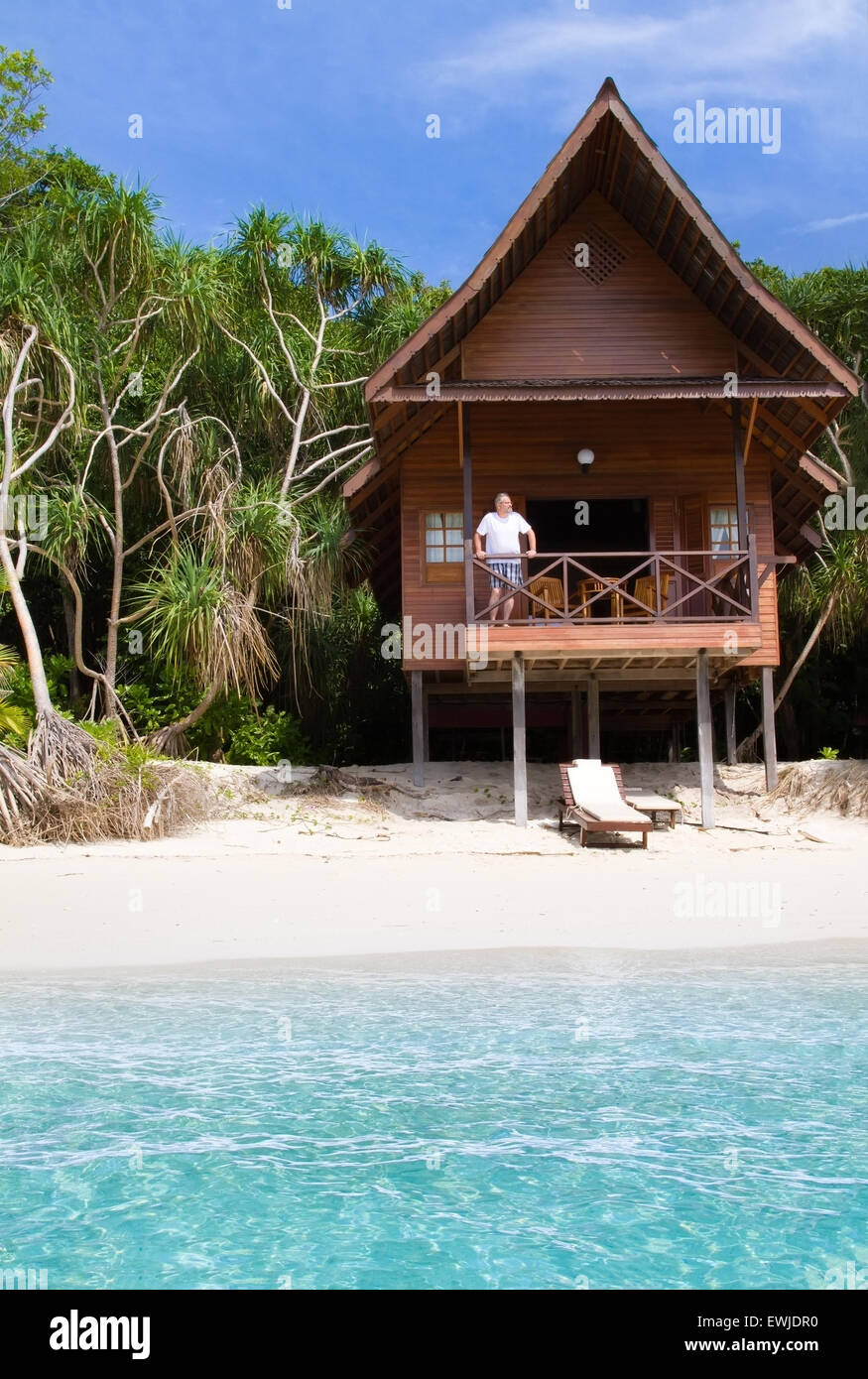 Mature man watching the ocean from a tropical bungalow Stock Photo - Alamy