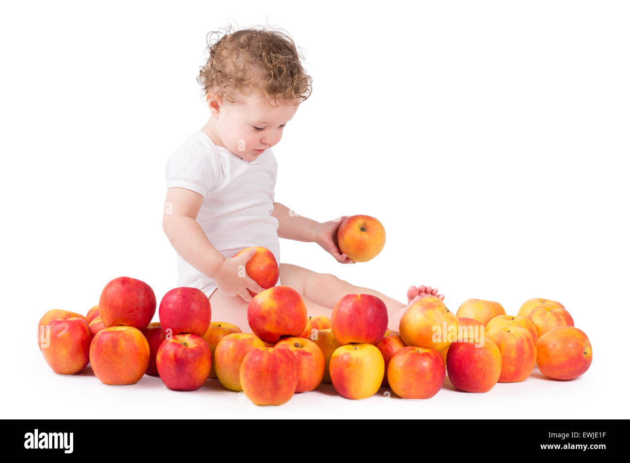 Sweet baby eating a red apple, on white background Stock Photo - Alamy