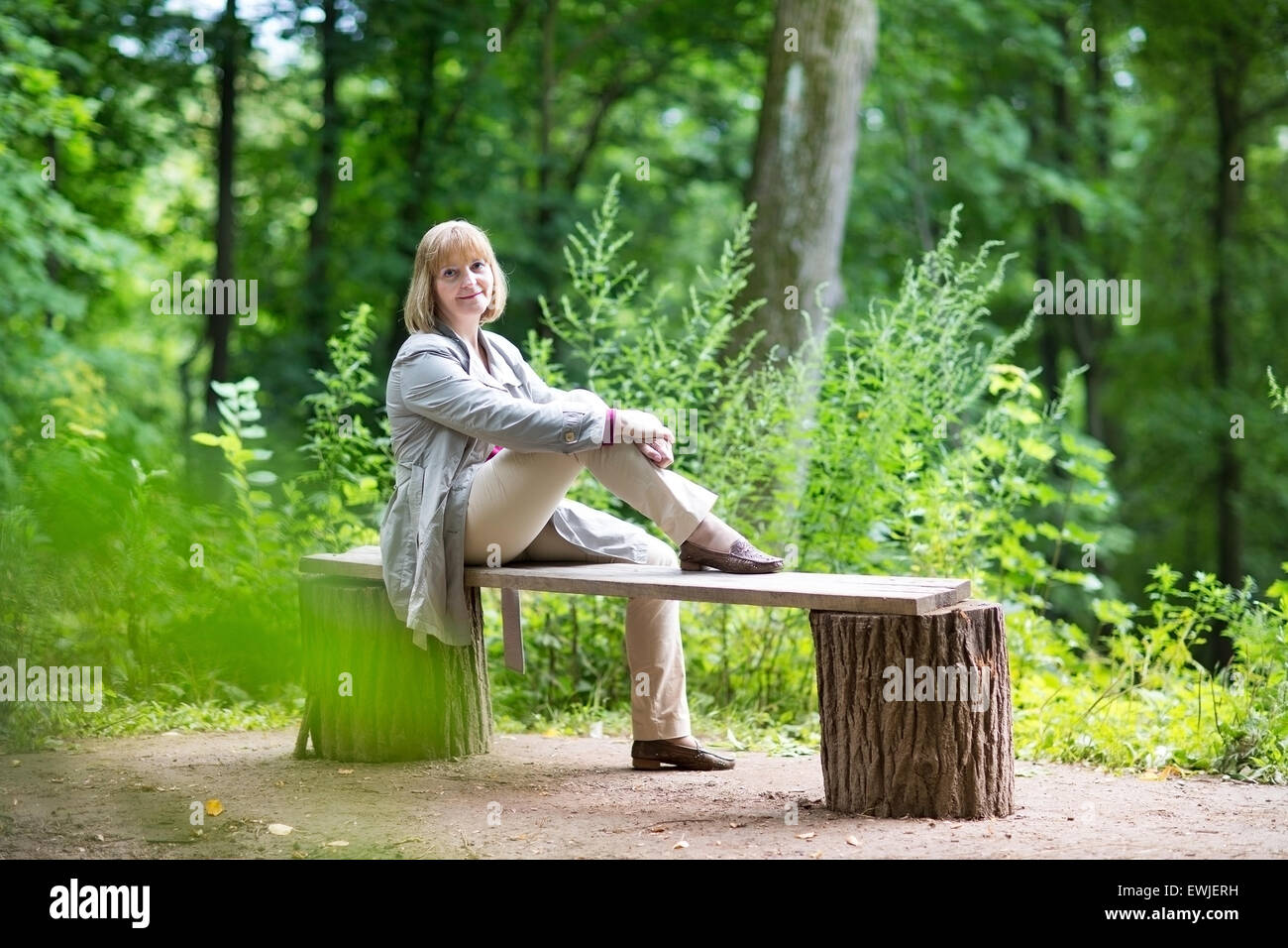 Beautiful lady relaxing in a park on a rainy autumn day Stock Photo - Alamy