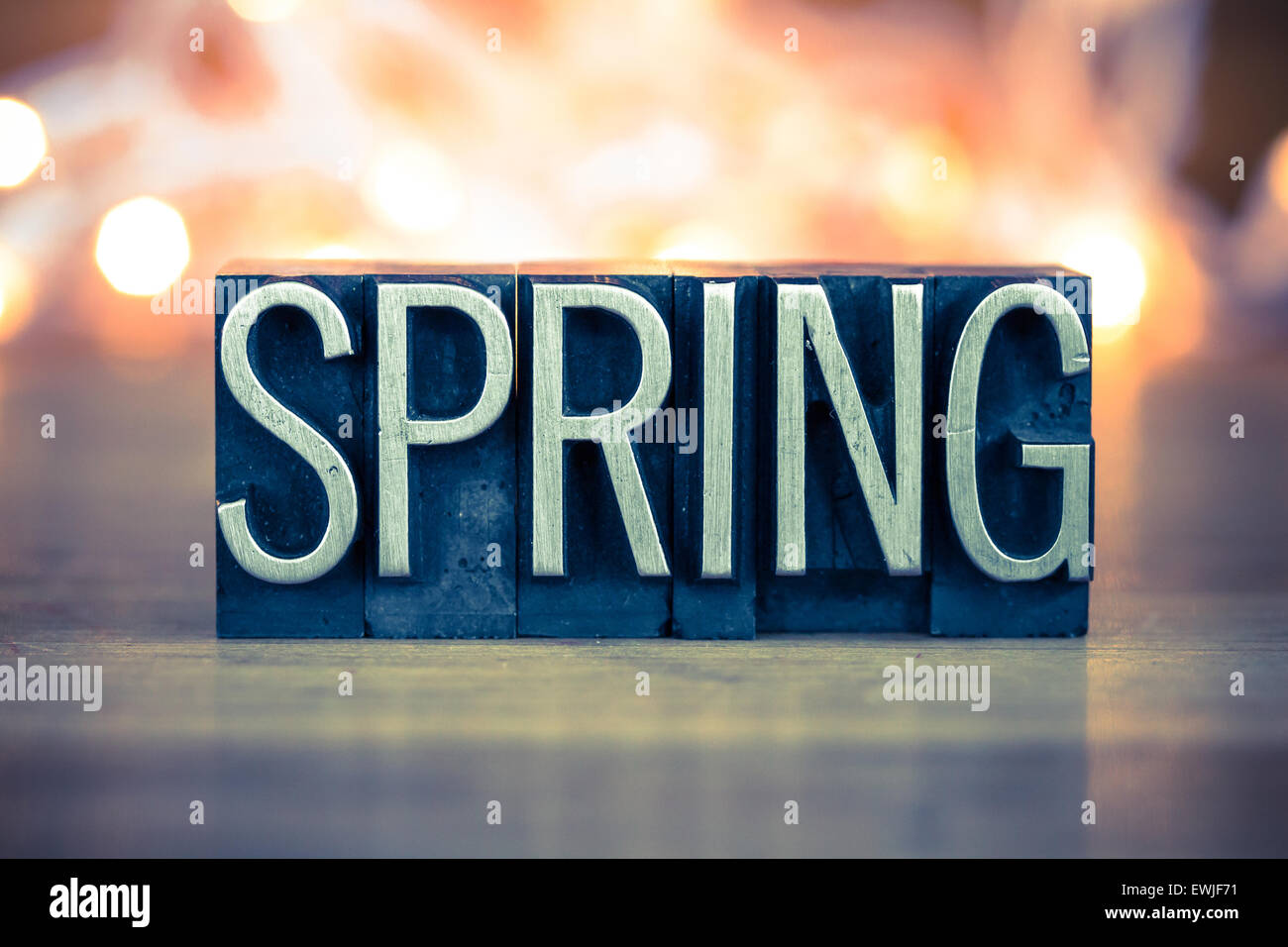 The word SPRING written in vintage metal letterpress type on a soft ...